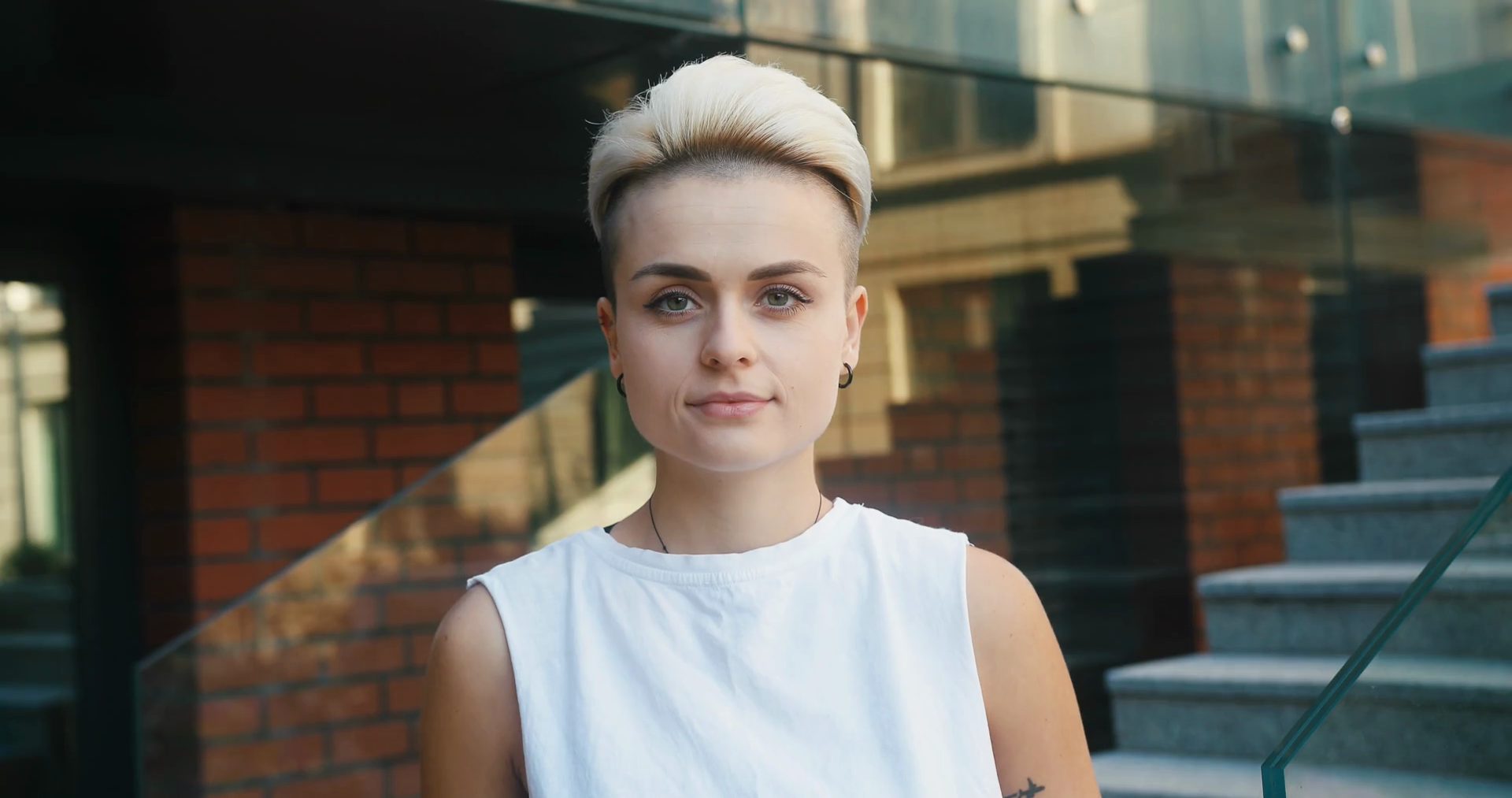 Young woman squints eyes and smiles putting hands on fencing Stock ...