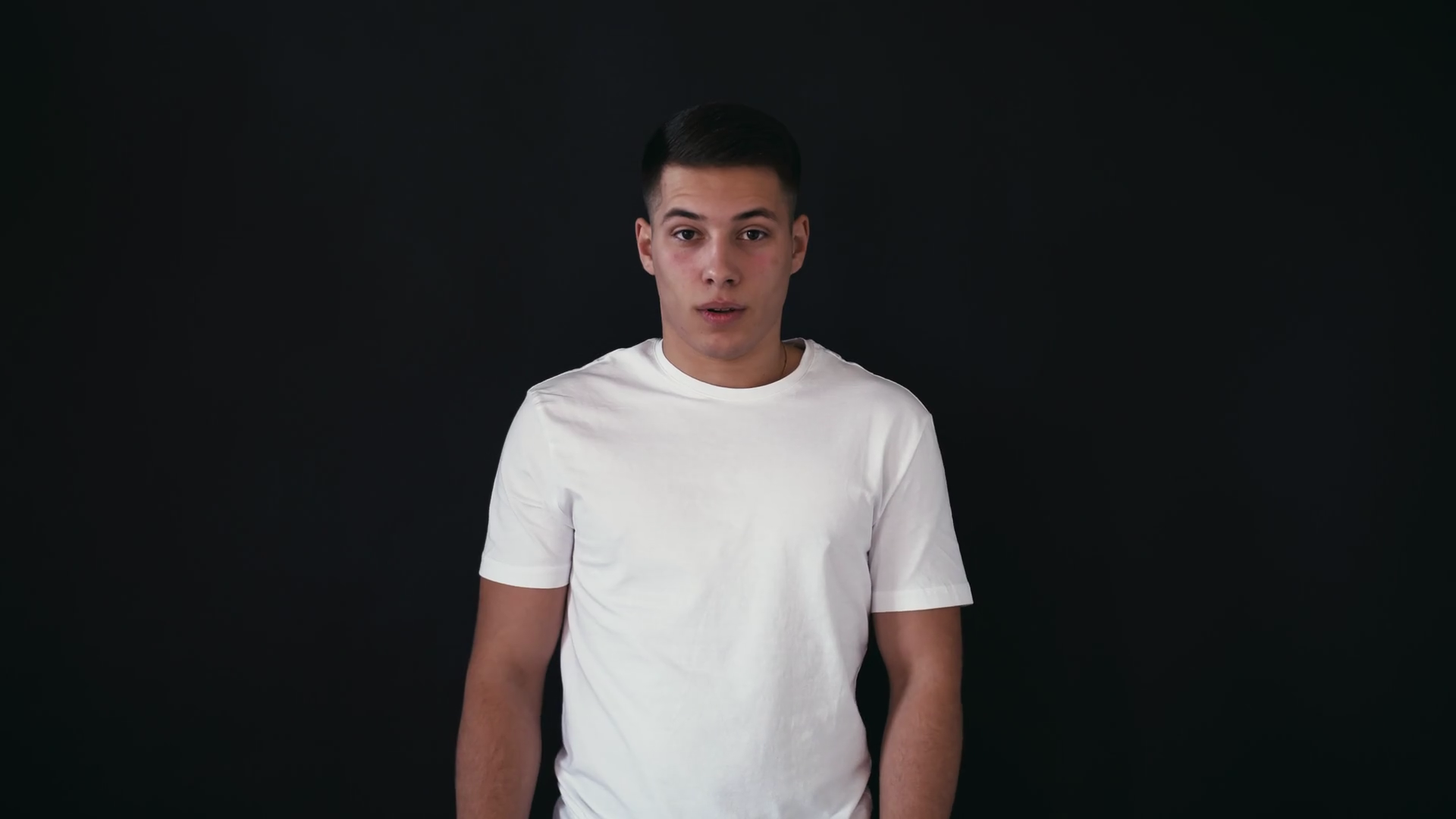 Calm and peaceful guy at first stand and looks on camera. He is calm ...