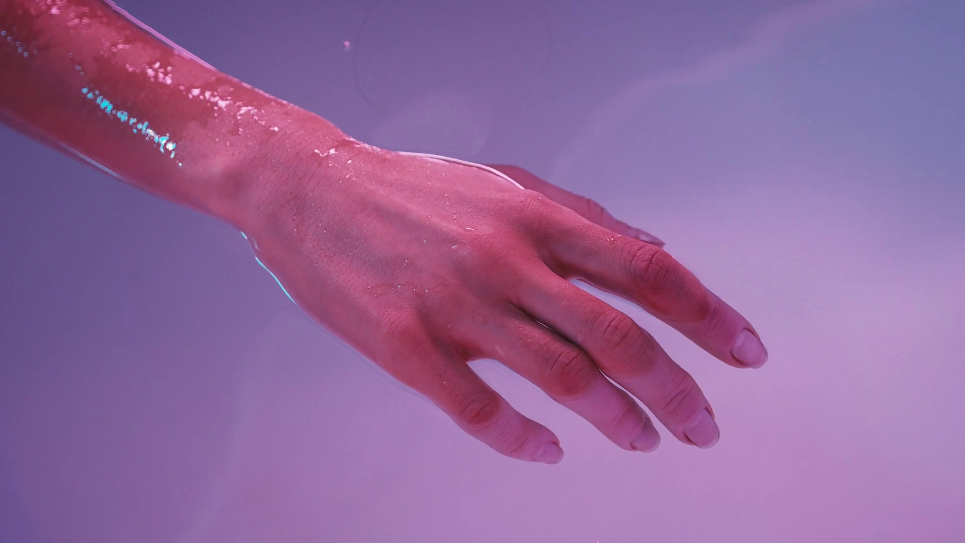 Young womans hand floating in Spa bath or swimming pool, she is very ...