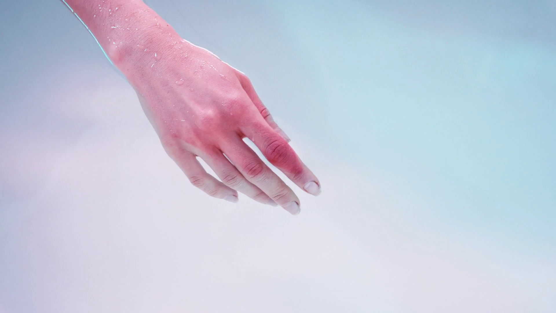 Young womans hand floating in Spa bath or swimming pool, she is very ...