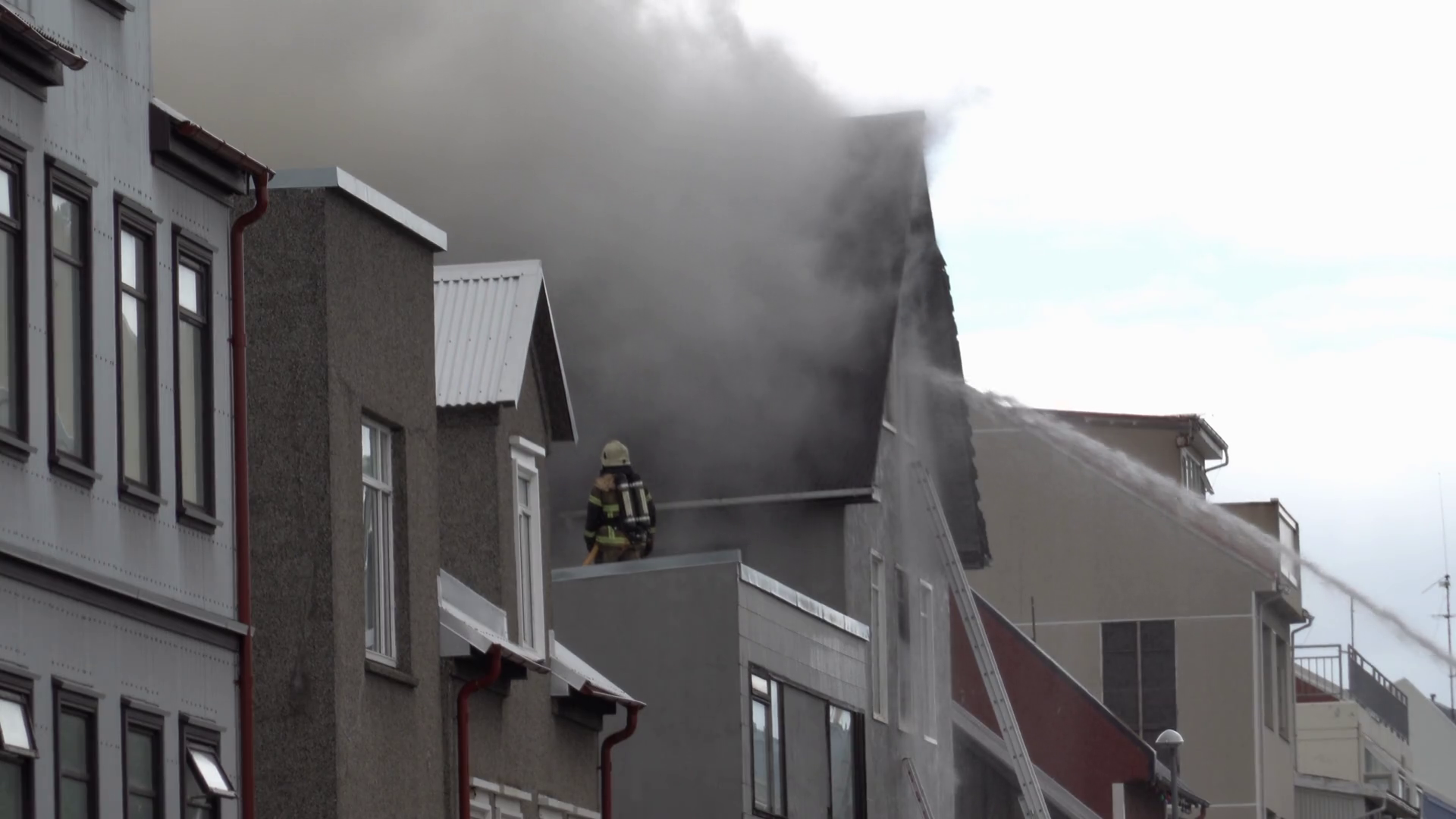 Firefighter On Roof Putting Out House Fire Stock Footage SBV-348366200 ...