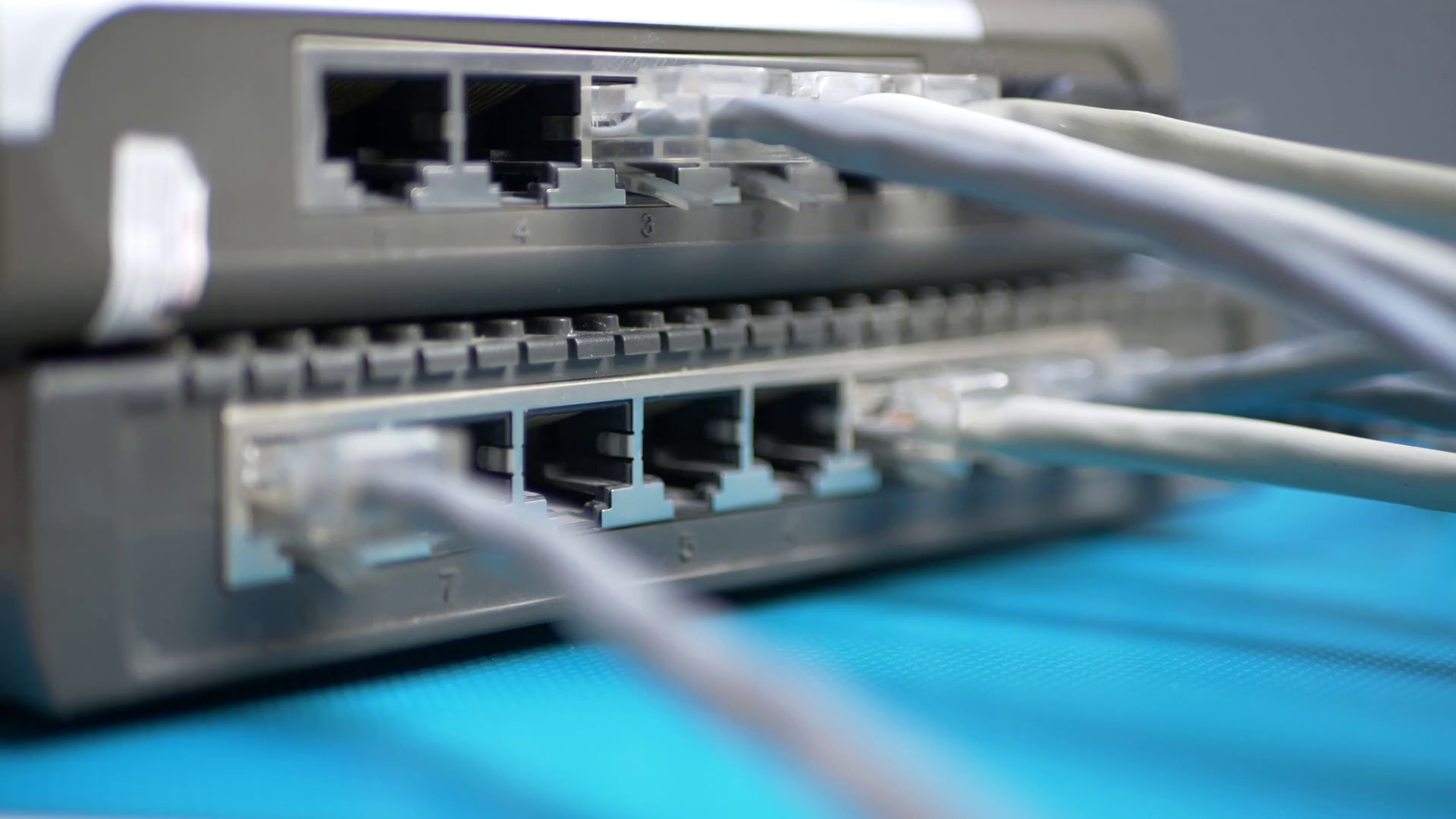 Hand Plugs Ethernet Cable into Router on Green Background in Office ...