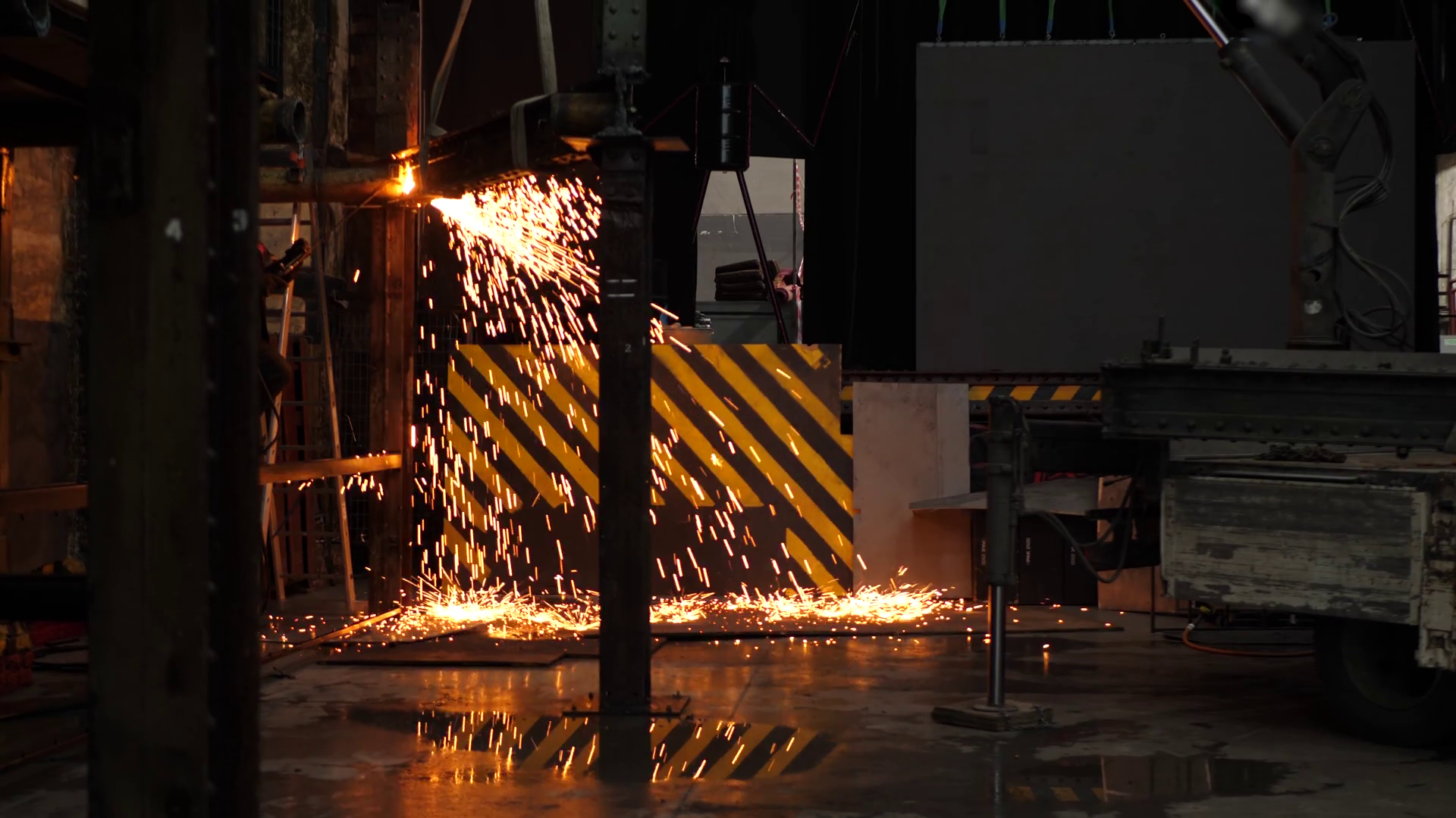 Sparks from grinding machine in workshop. Heavy industry worker cutting ...