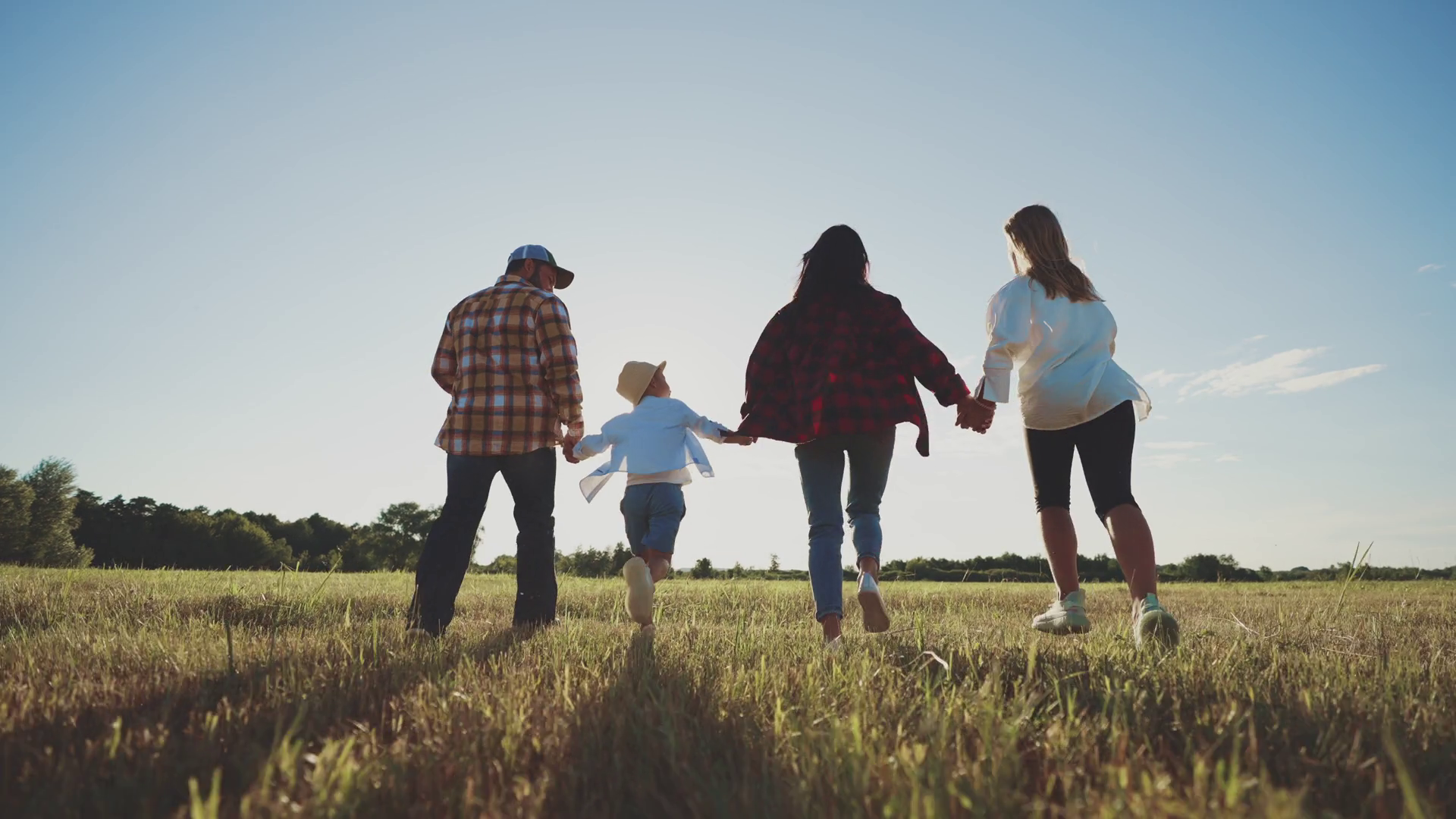 Back View Of Family Of Four Running On Field Stock Footage SBV ...