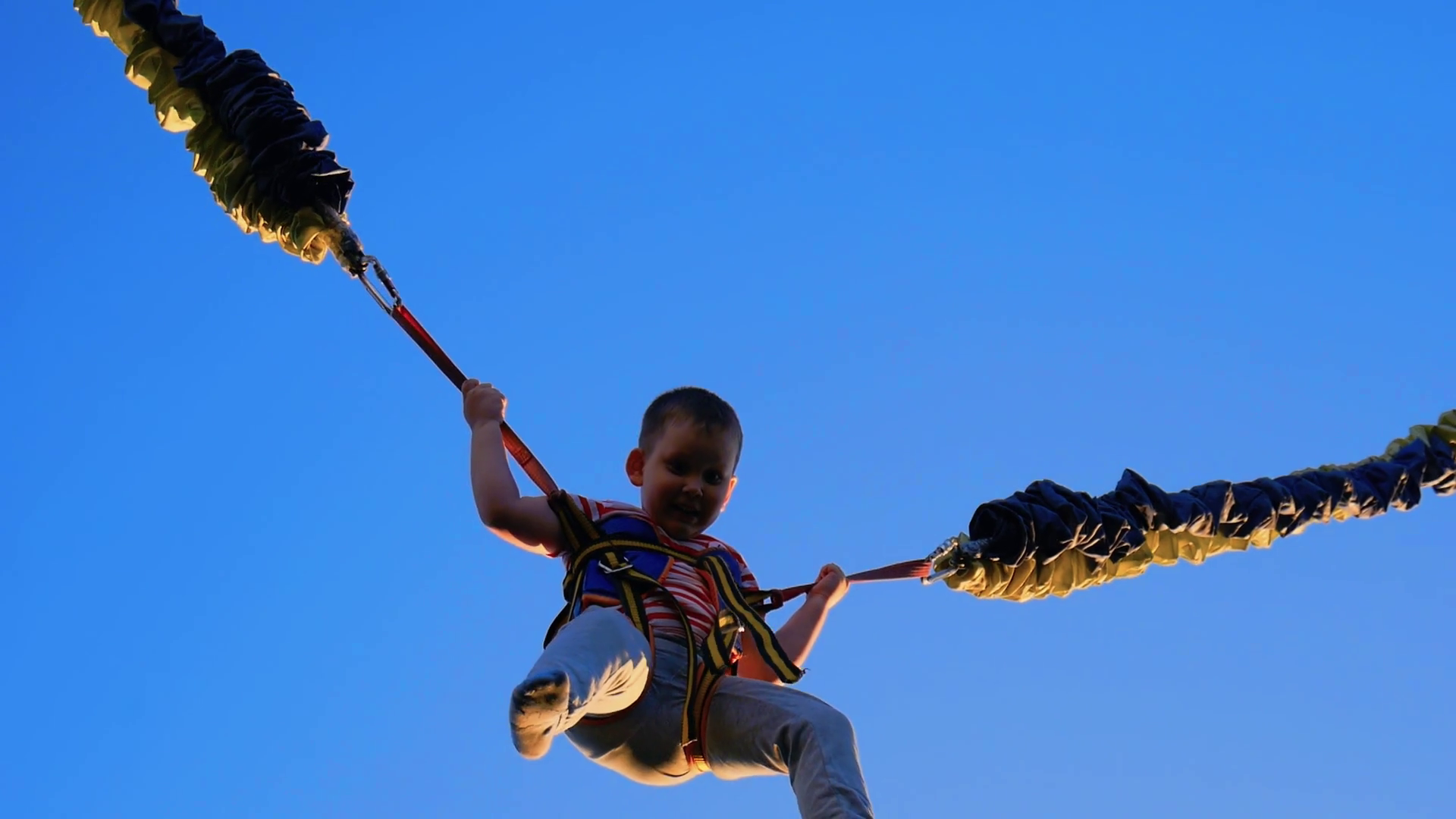 Boy Jumping On Trampoline With Elastic Ropes Stock Footage SBV ...