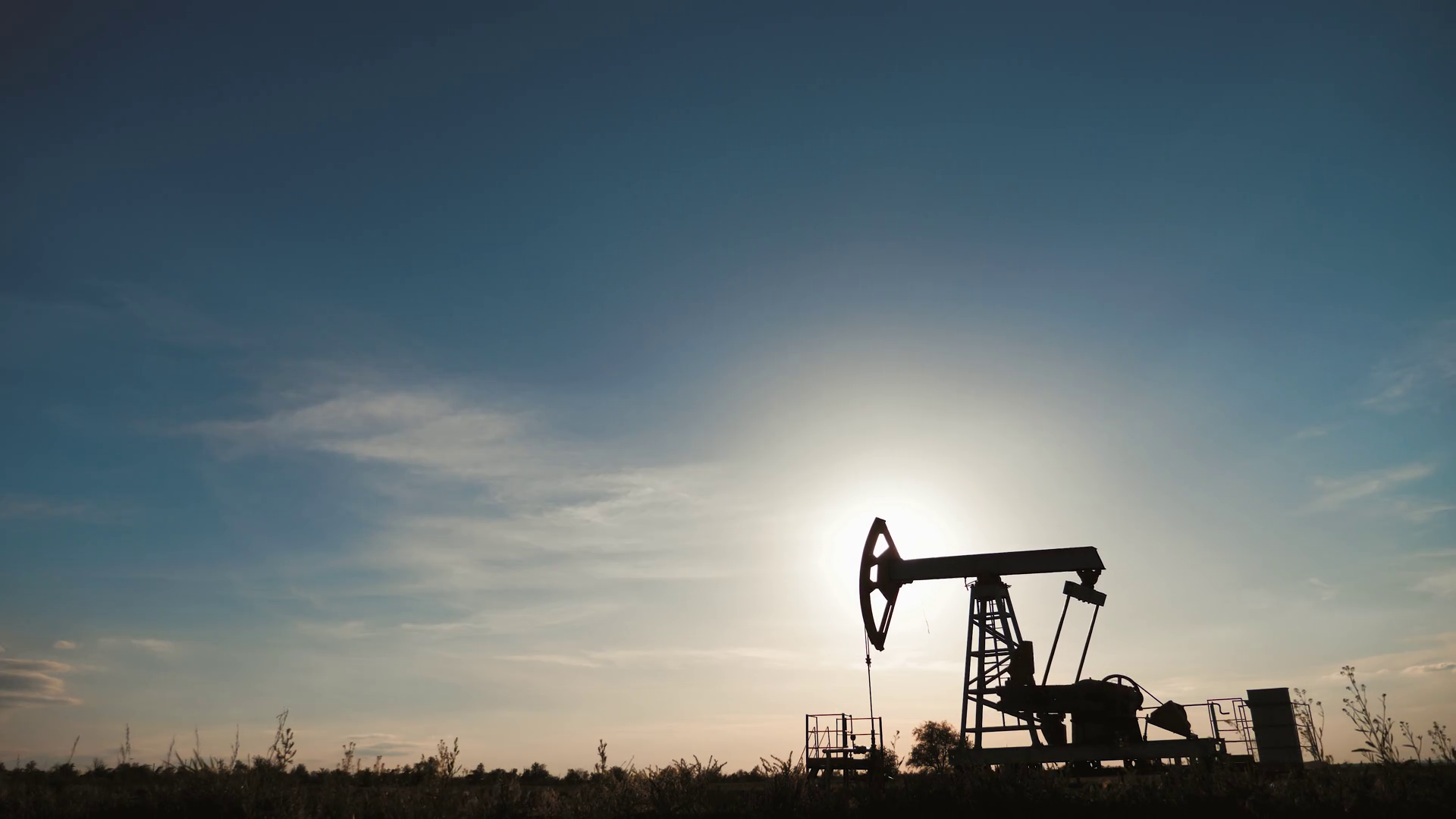 Silhouette of working oil pump from oil field at sunset. The industrial ...