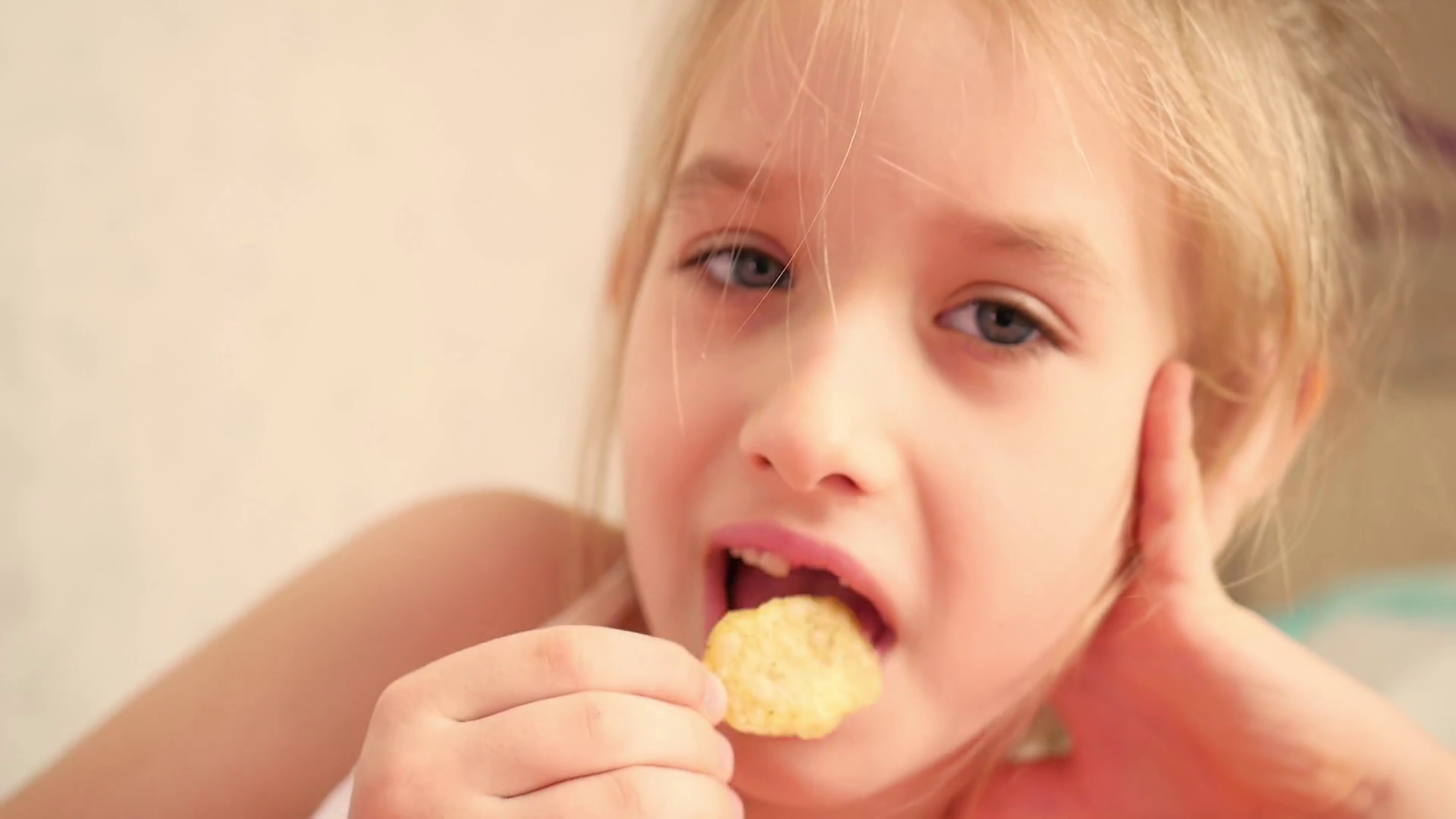 Indoor Snacking: Young Girl Enjoying Chips Stock Footage SBV-320353164 ...