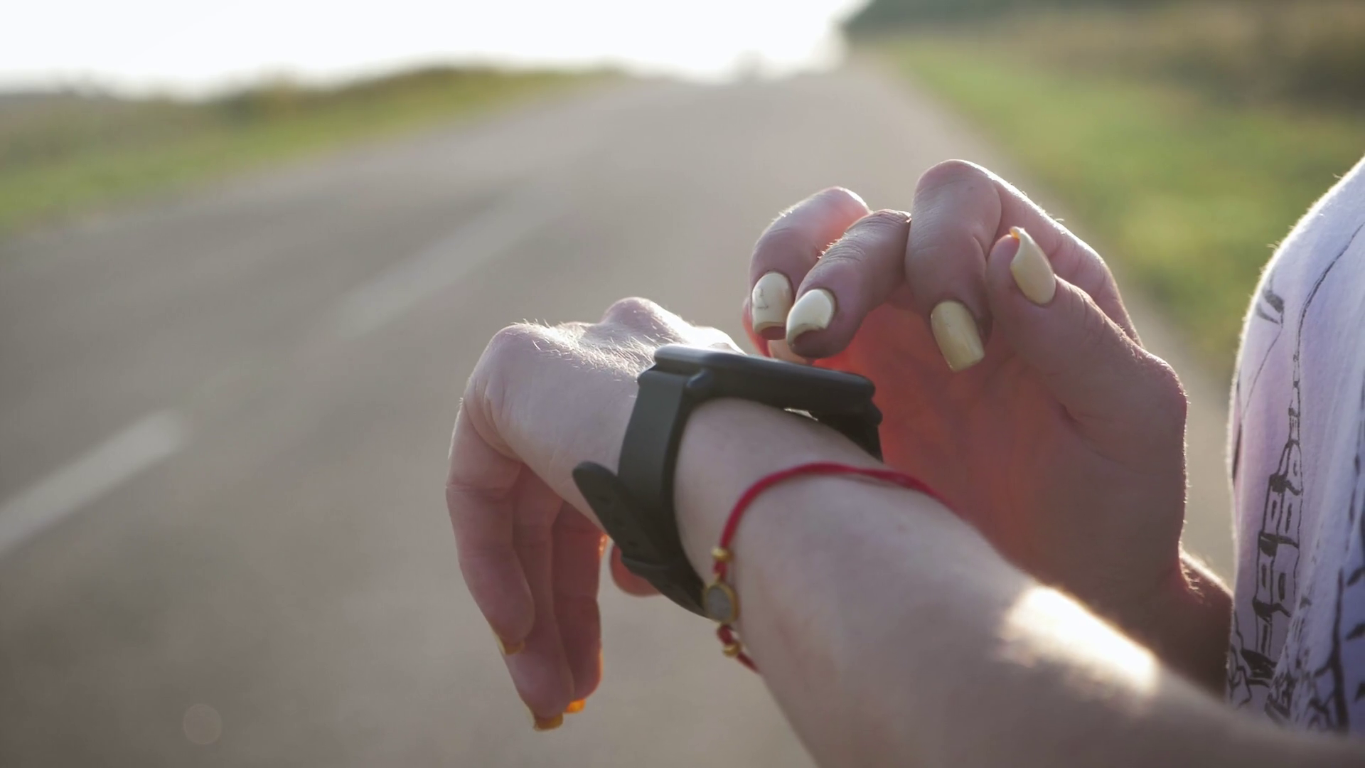 Young woman runner looking at sports smart watch, checking performance ...