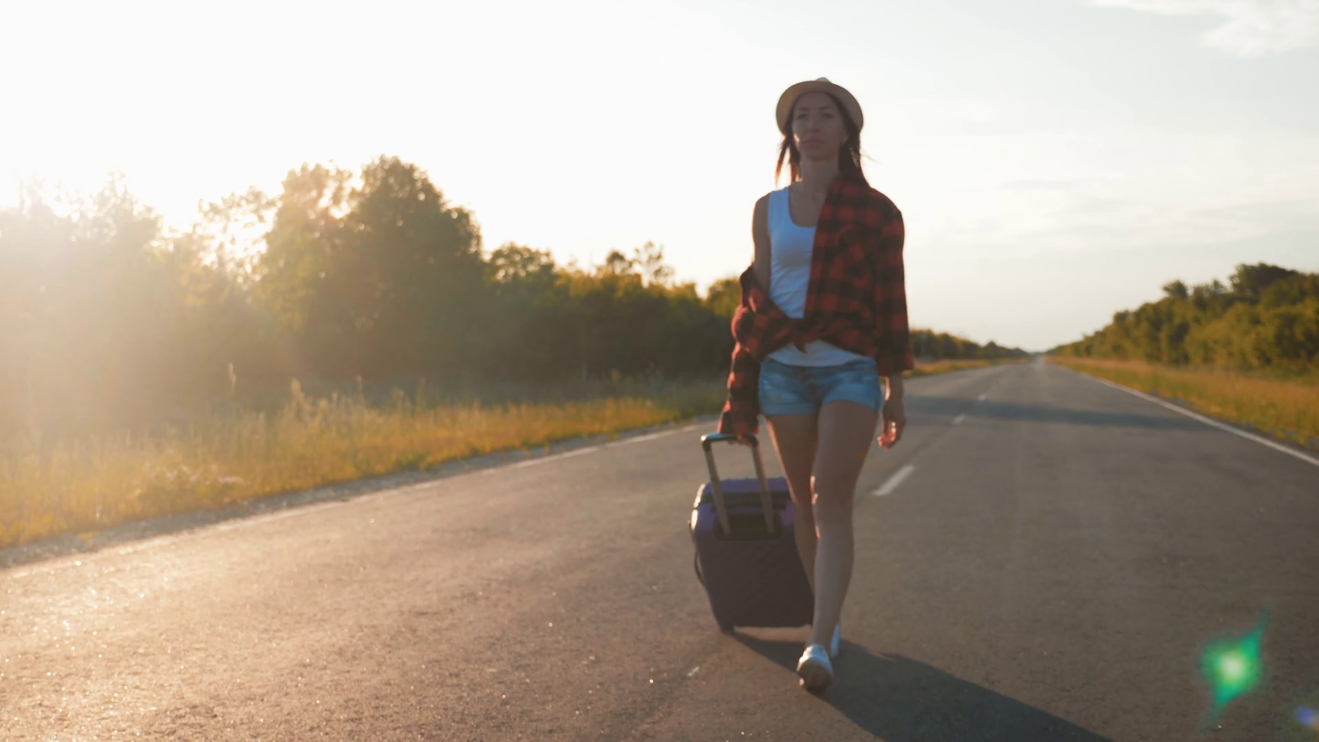 Young woman with a suitcase on road. Funny beautiful girl traveler ...