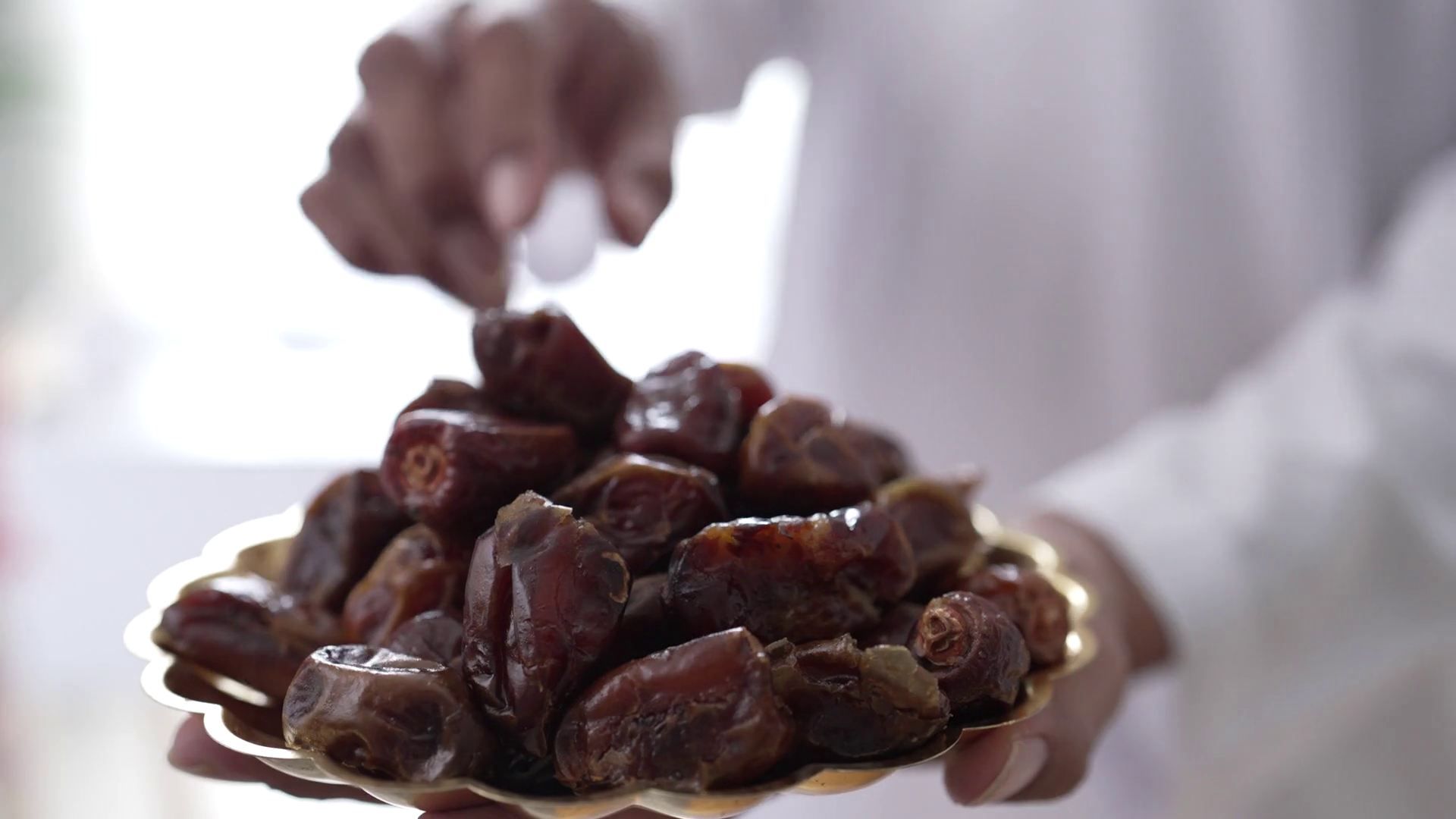 muslim's hand taking dates fruit while enjoying iftar dinner together ...