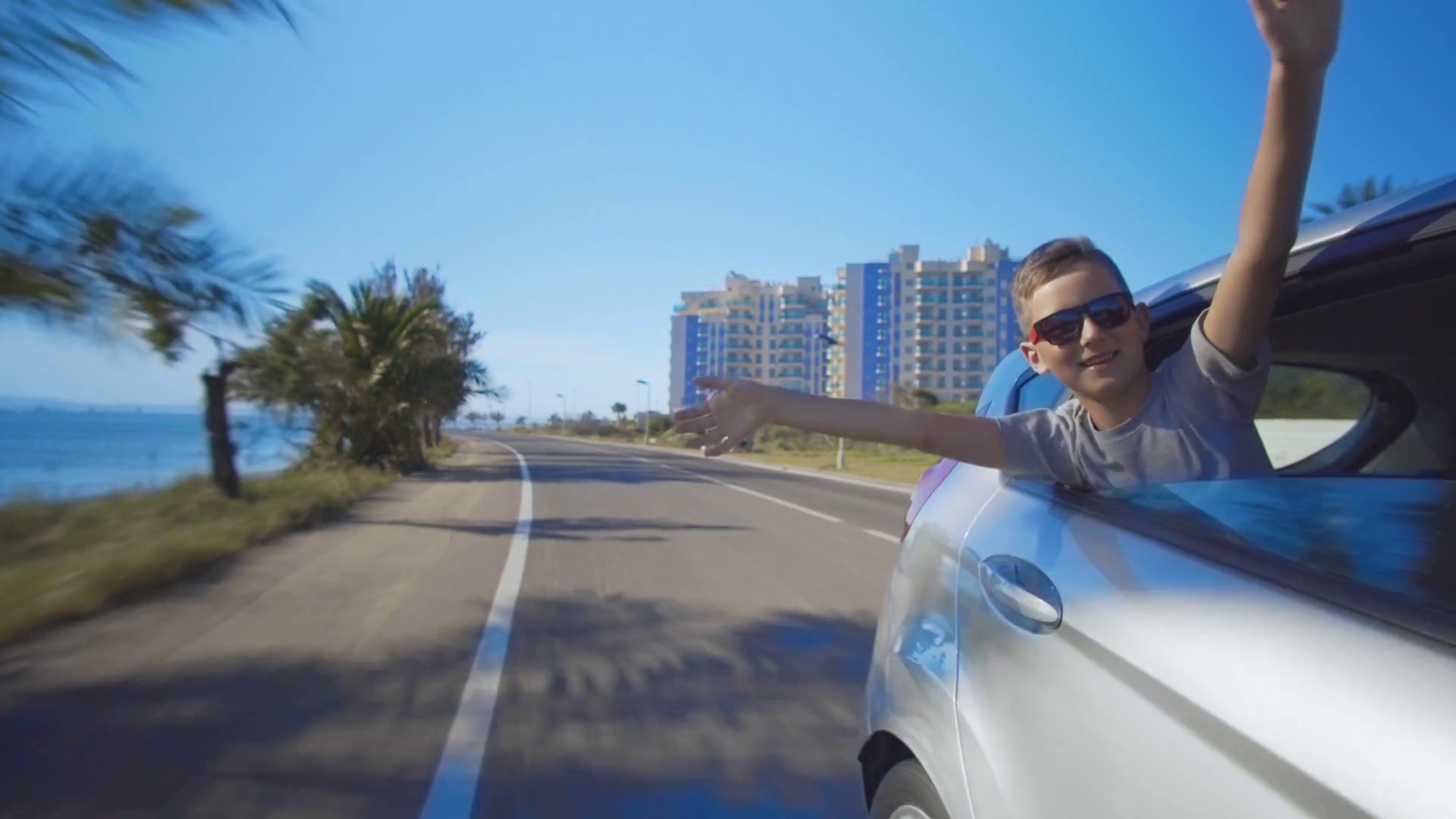 Boy Looking Out Car Window Waving Hand Stock Footage SBV-336617834 ...