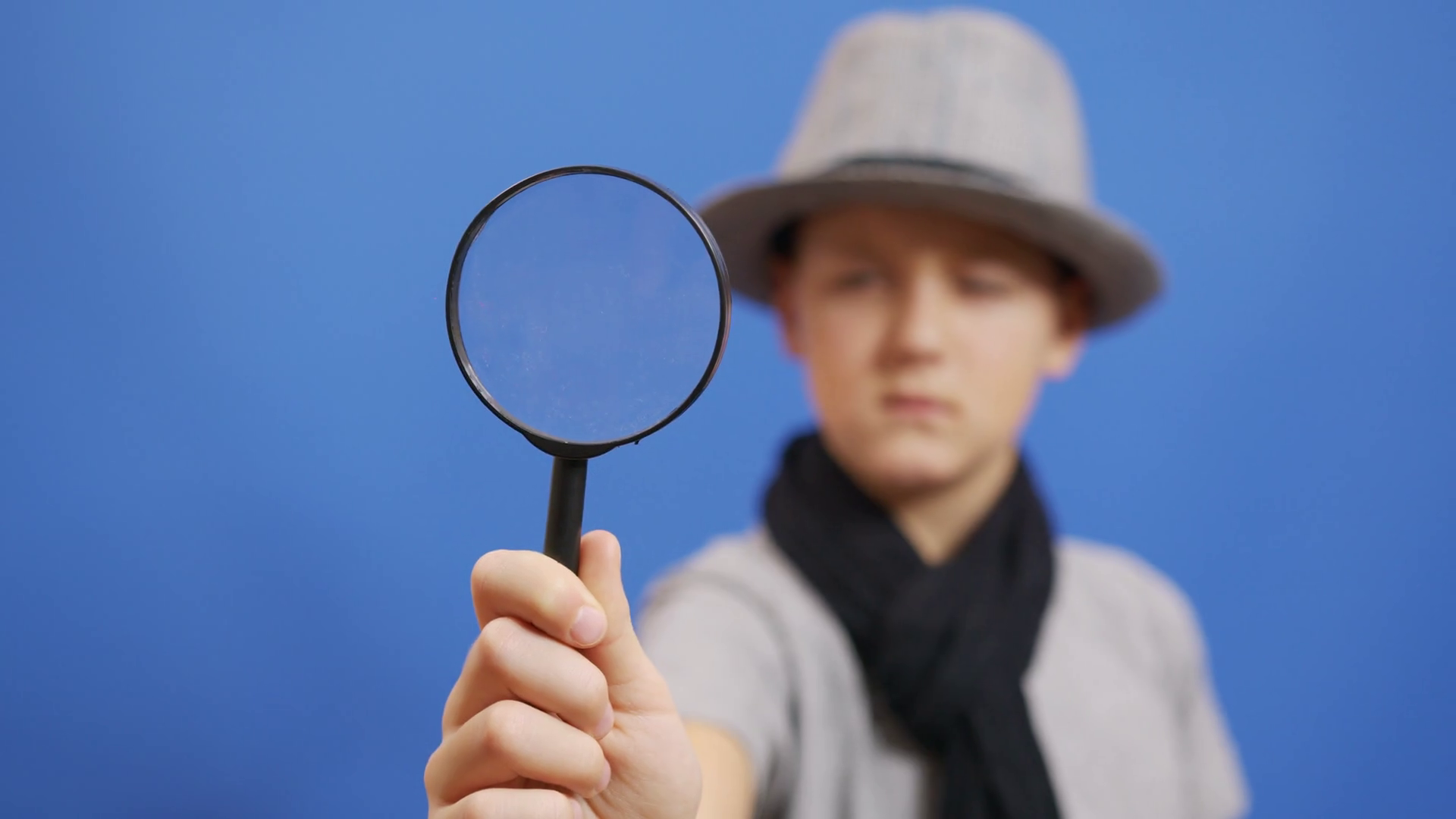 Search with a magnifier. A little boy search something with a magnifier ...