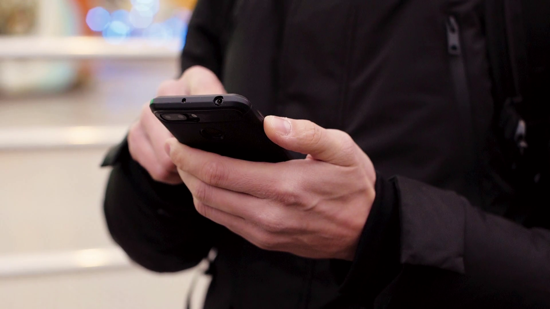 Close-up portrait of young handsome man standing outdoors alone smiling ...