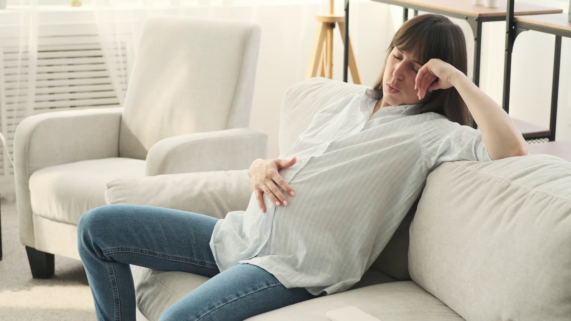 Tired Pregnant Woman Embracing Baby Bump At Stock Footage SBV-347769333 ...