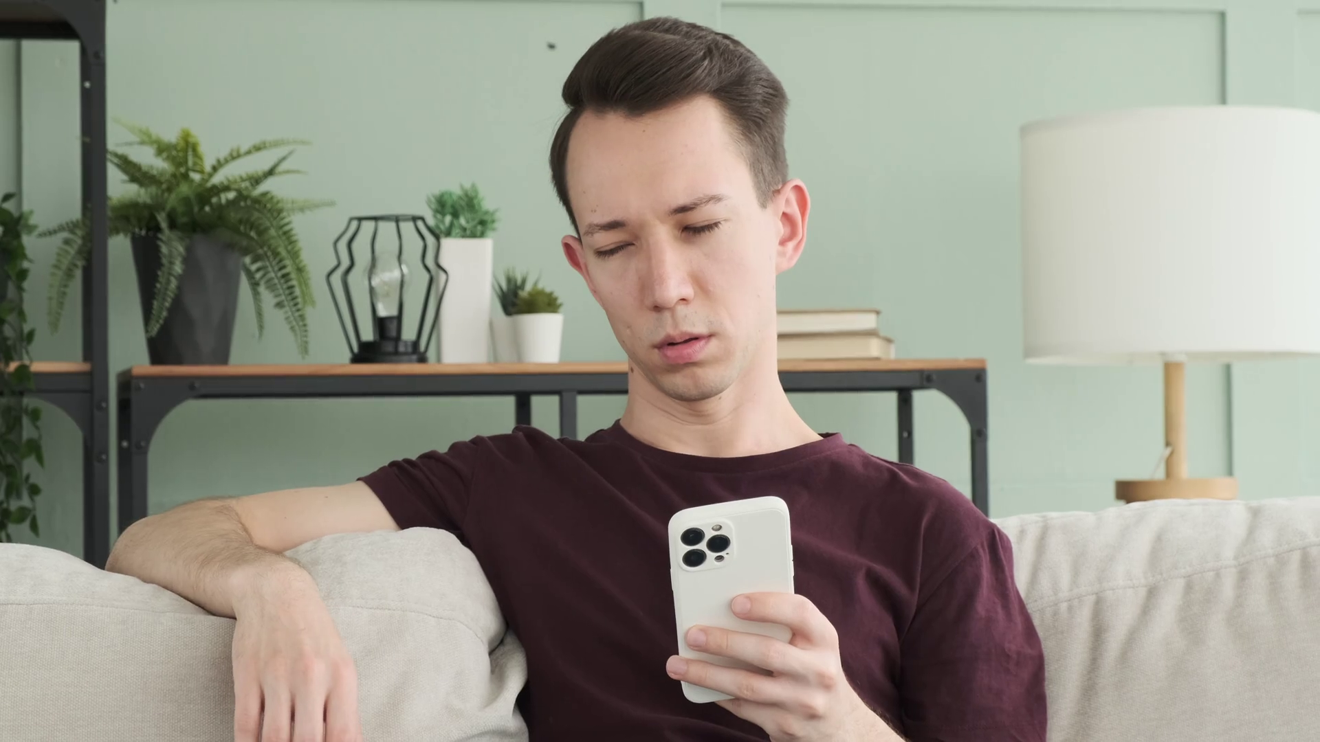 Bored Man Yawning Using Phone On Sofa Stock Footage SBV-348388631 ...