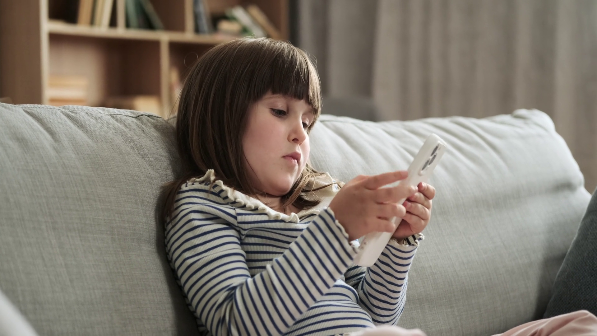 Serious Girl Browsing Phone On Couch Stock Footage SBV-348622722 ...