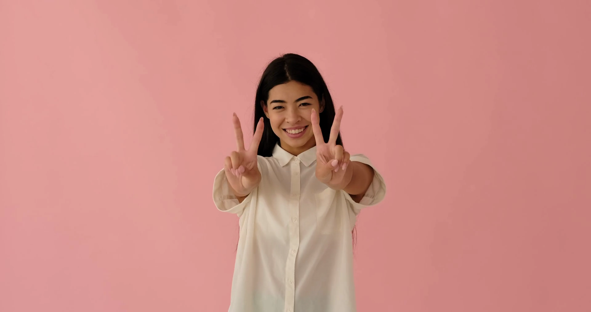 Happy woman giving v sign using both the hands Stock Video Footage 00: ...