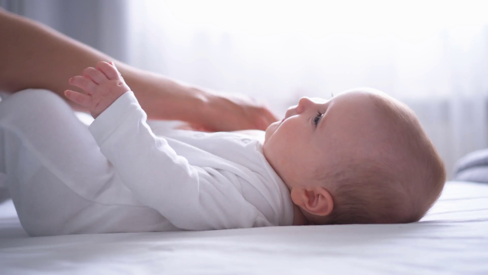 Mother Carefully Dressing Baby Stock Footage SBV-323646198 - Storyblocks