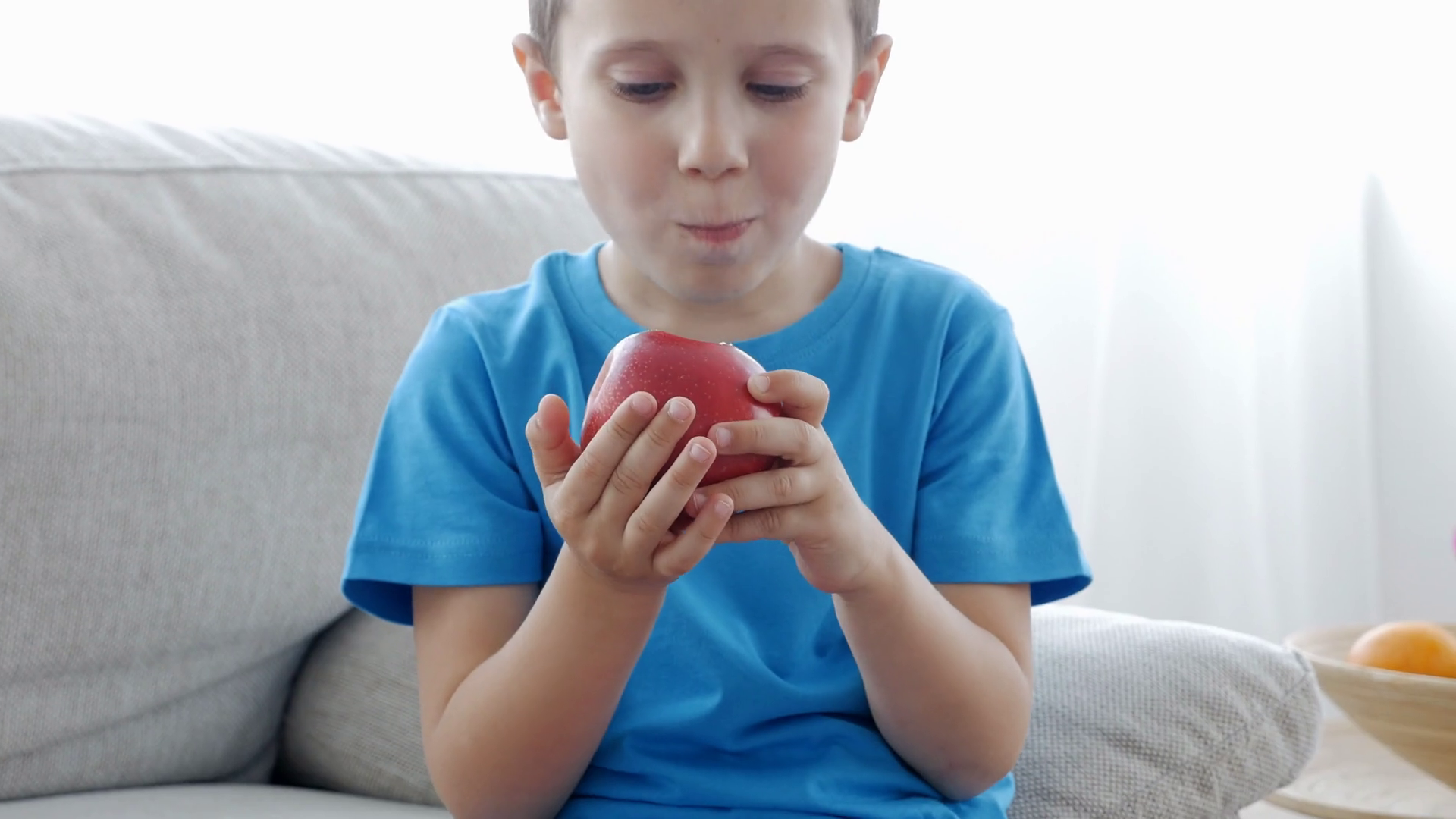 Smiling Child Eating Red Apple In Living Room Stock Footage SBV ...
