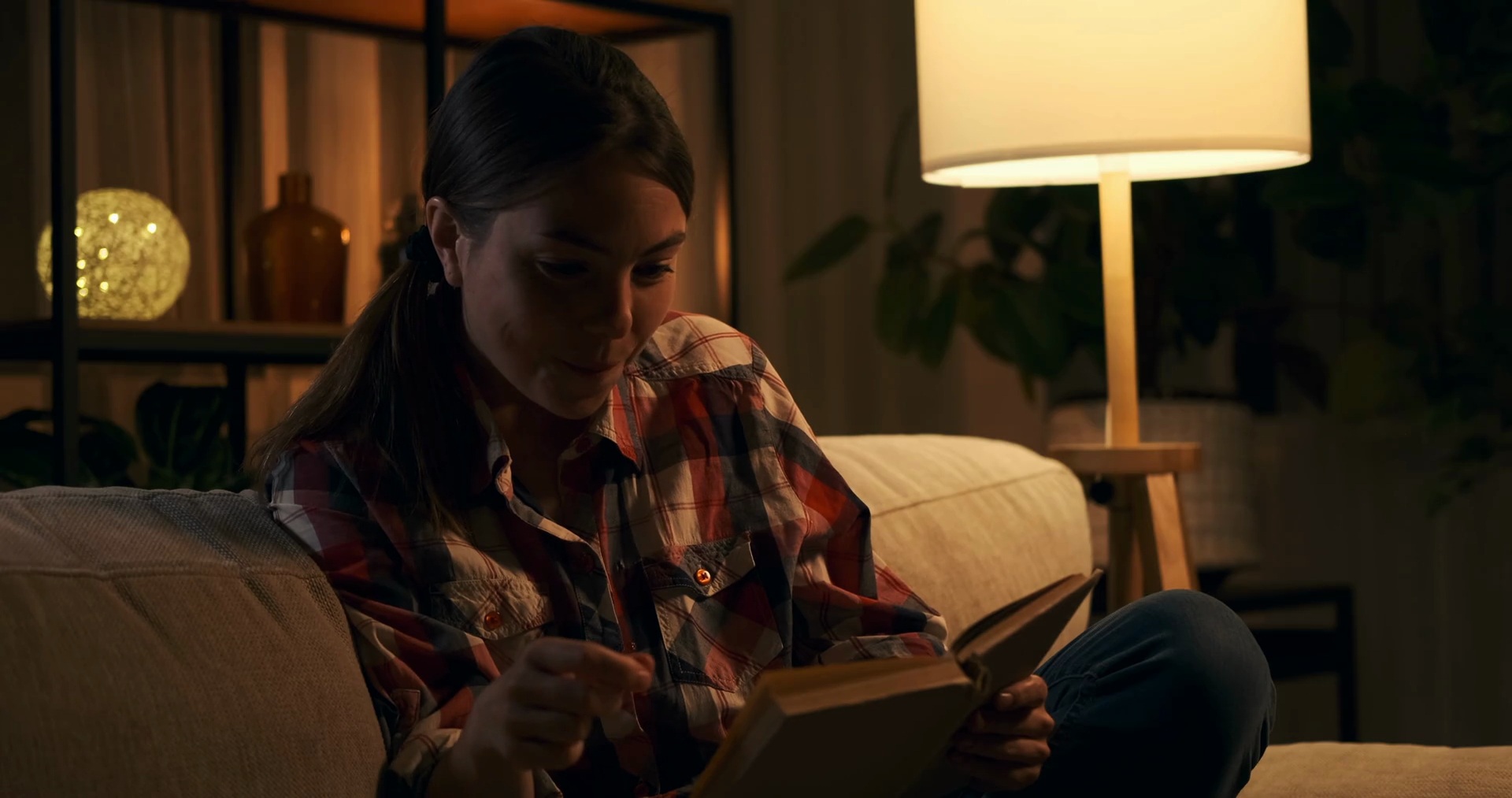 Woman Reading Book Eating Popcorn On Sofa At Stock Footage SBV ...