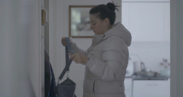 Woman Putting On Coat Stock Footage: Royalty-Free Video Clips - Storyblocks