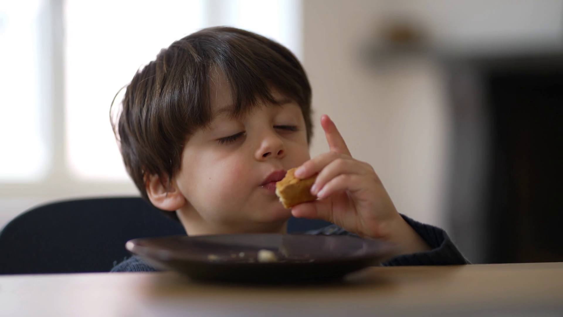 Child Eating Bread Snack Sitting At Table Stock Footage SBV-348779186 ...