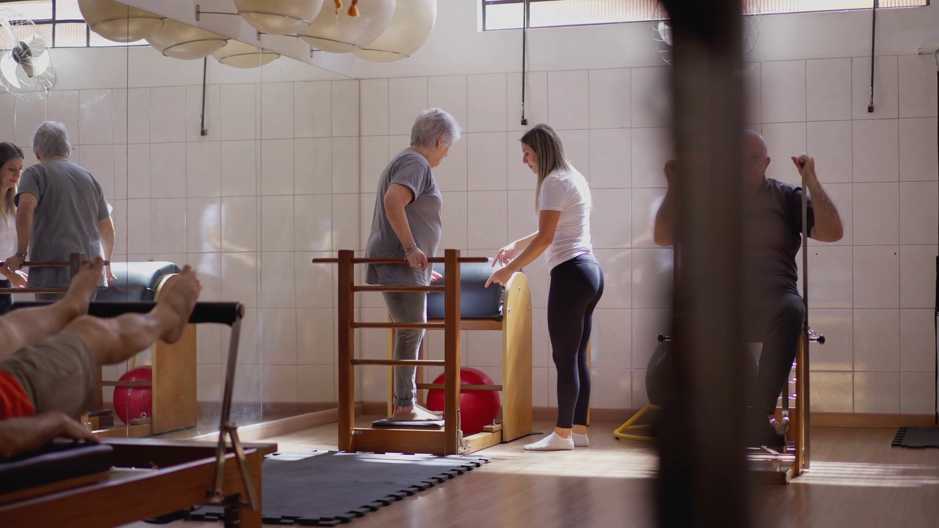 Female Pilates Coach Assisting Senior In Stock Footage SBV-348510086 ...