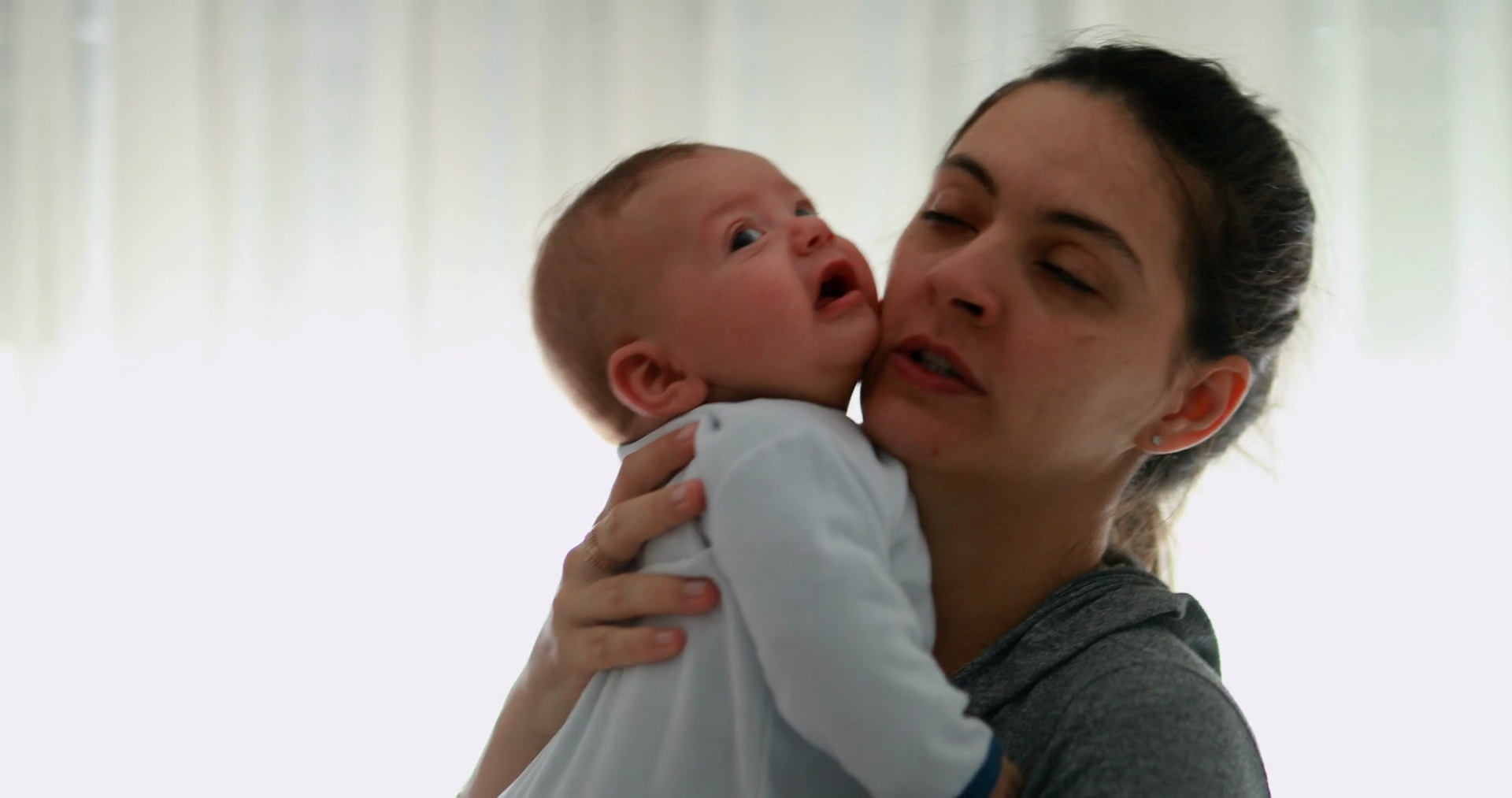 Curtain Comfort: Mother Consoles Crying Baby Stock Footage SBV-348426000 - Storyblocks
