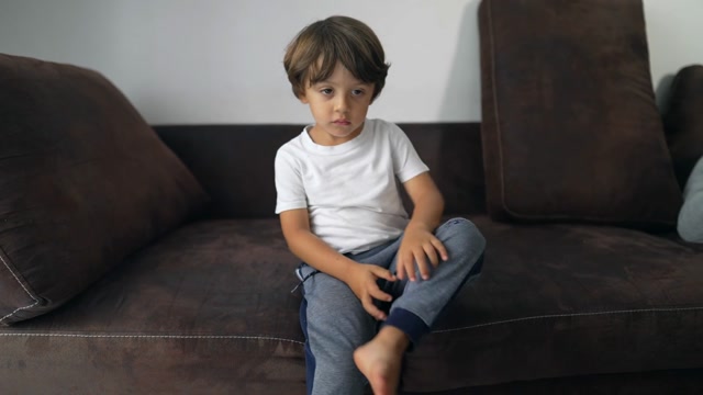 Boy Sitting Down Stock Footage: Royalty-Free Video Clips - Storyblocks