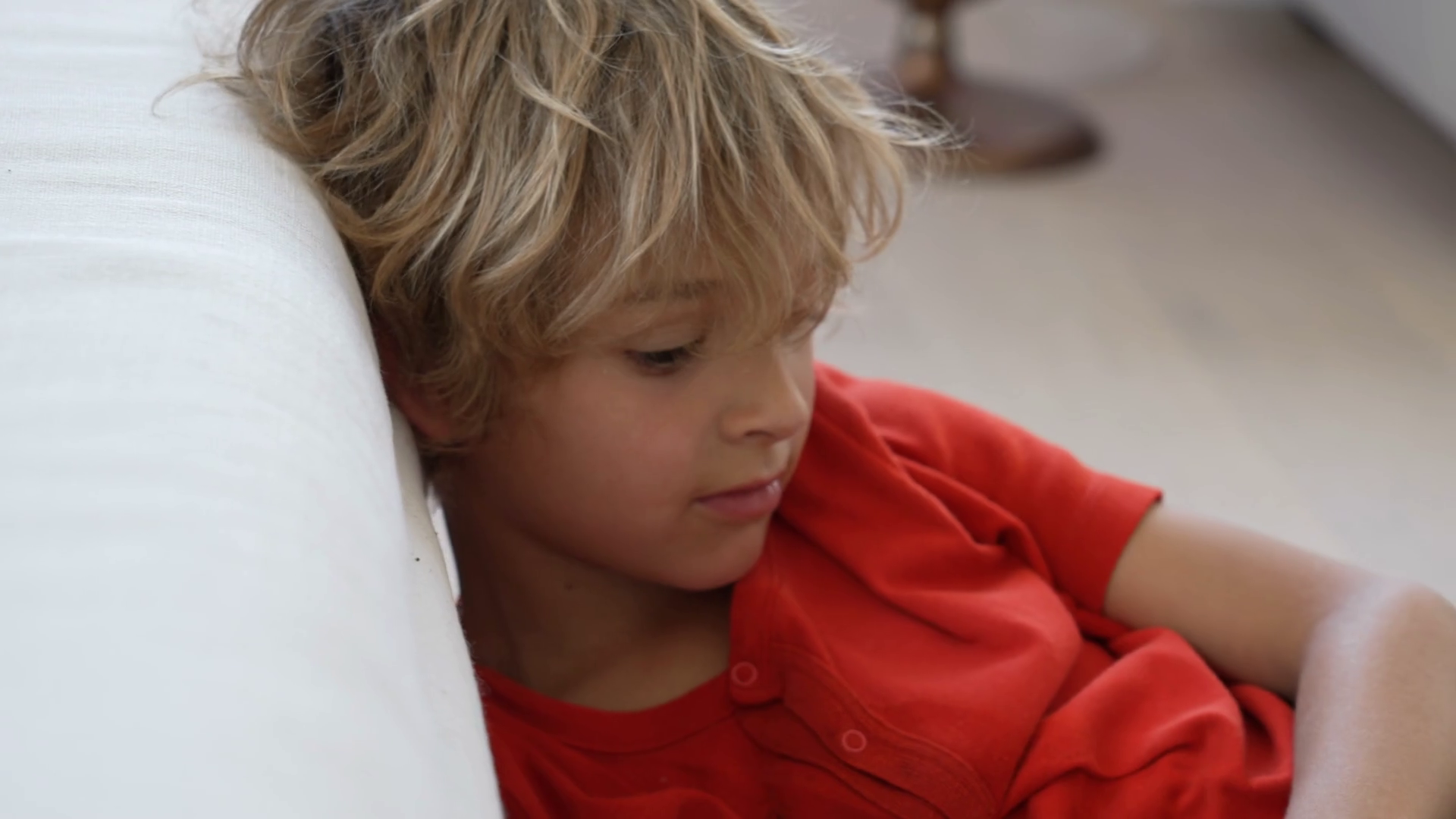One Bored Little Boy Leaning On Sofa At Home Stock Footage SBV ...