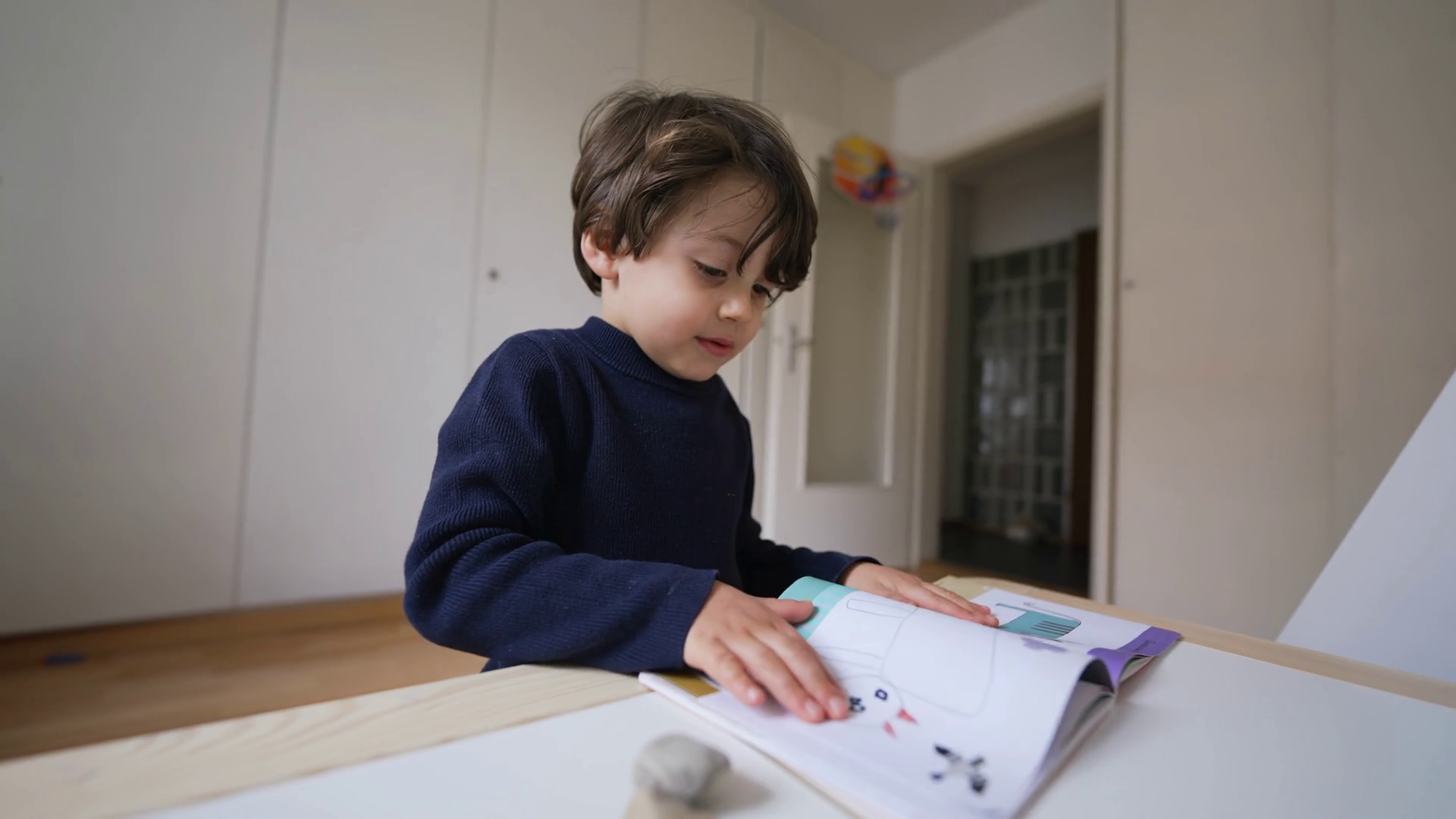 Small Boy Reading Book Sitting At Desk In Stock Footage SBV-348779286 ...