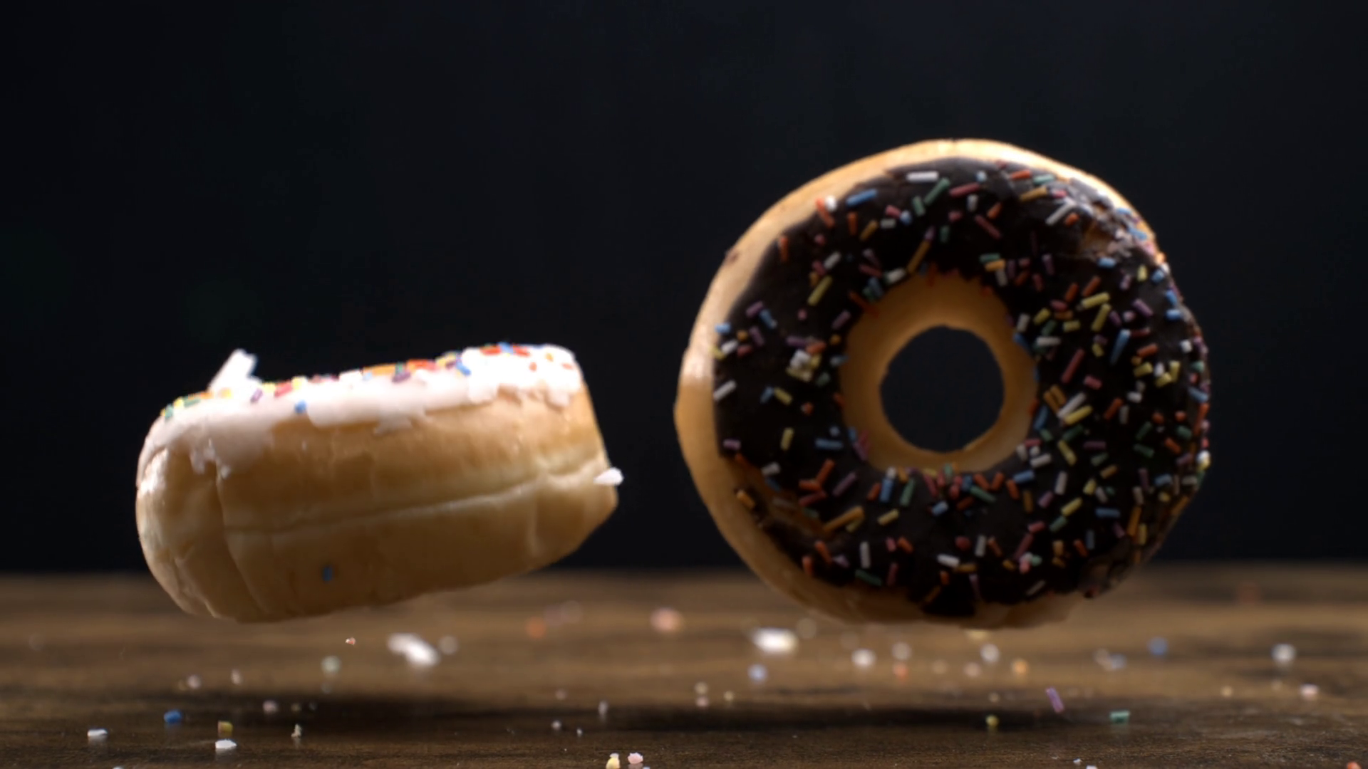 Two Large Donuts Falling Into Table Surface Stock Footage SBV-348983085 ...