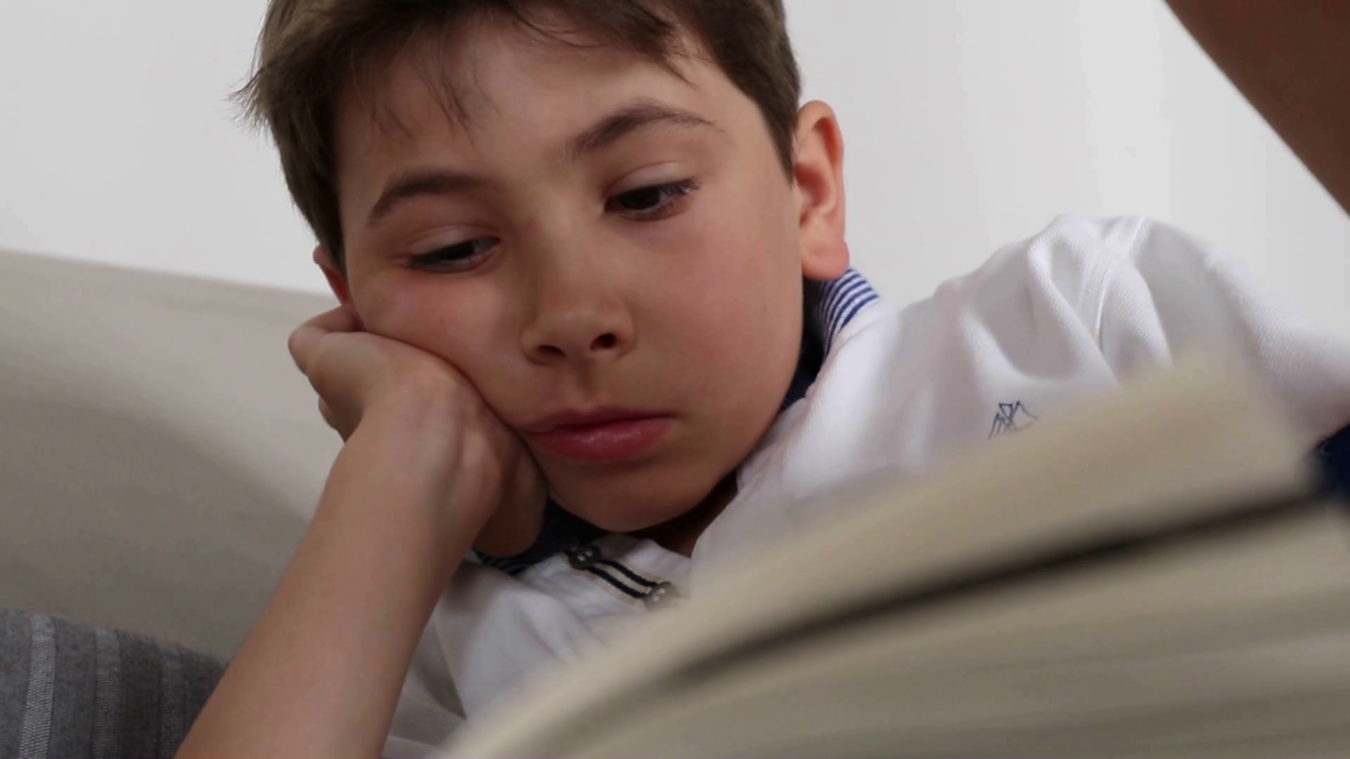 Young Boy Reading Book On Sofa Child Reading Stock Footage SBV ...