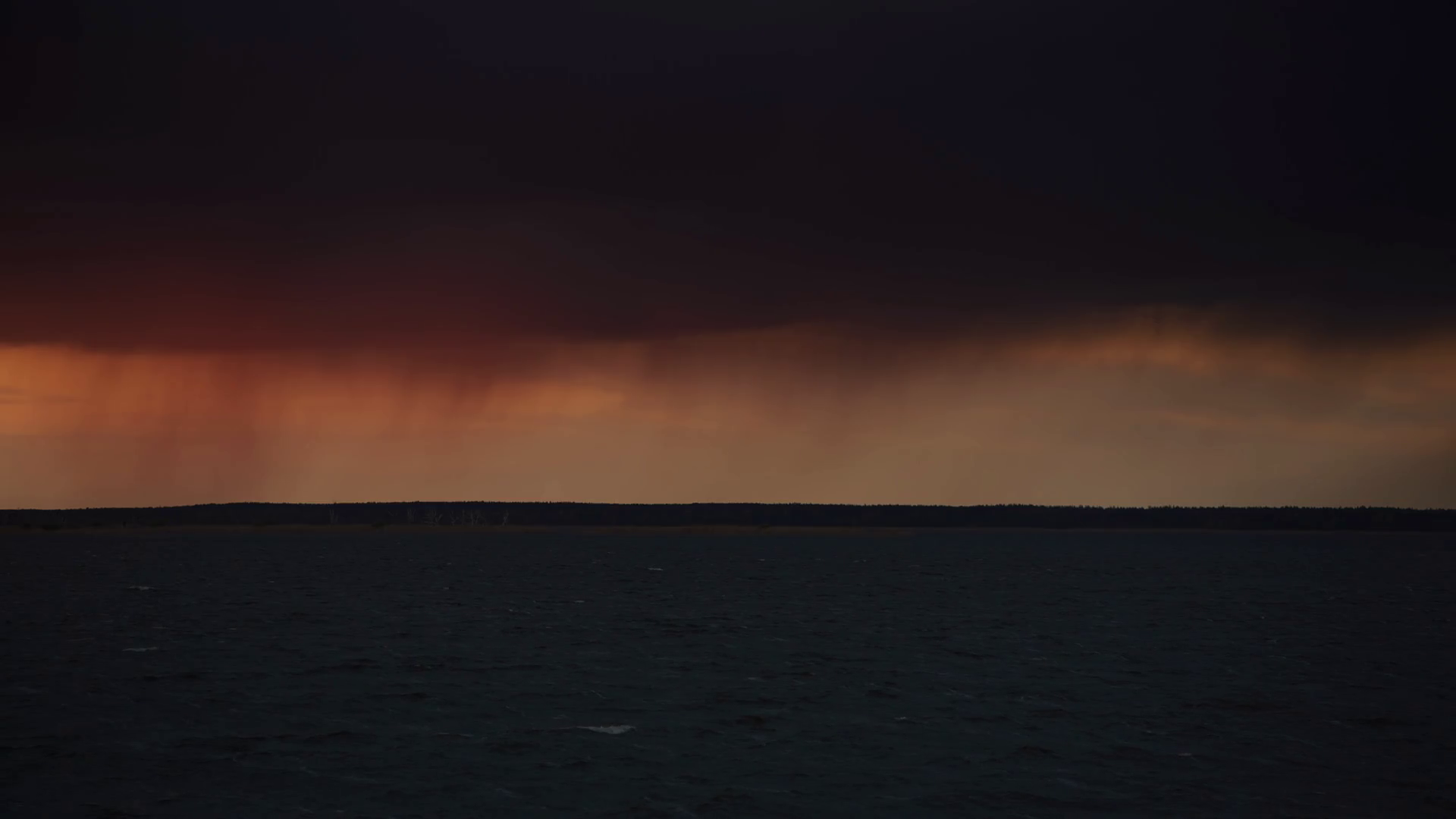 Scenic view on a river during storm with heavy distant rain during ...