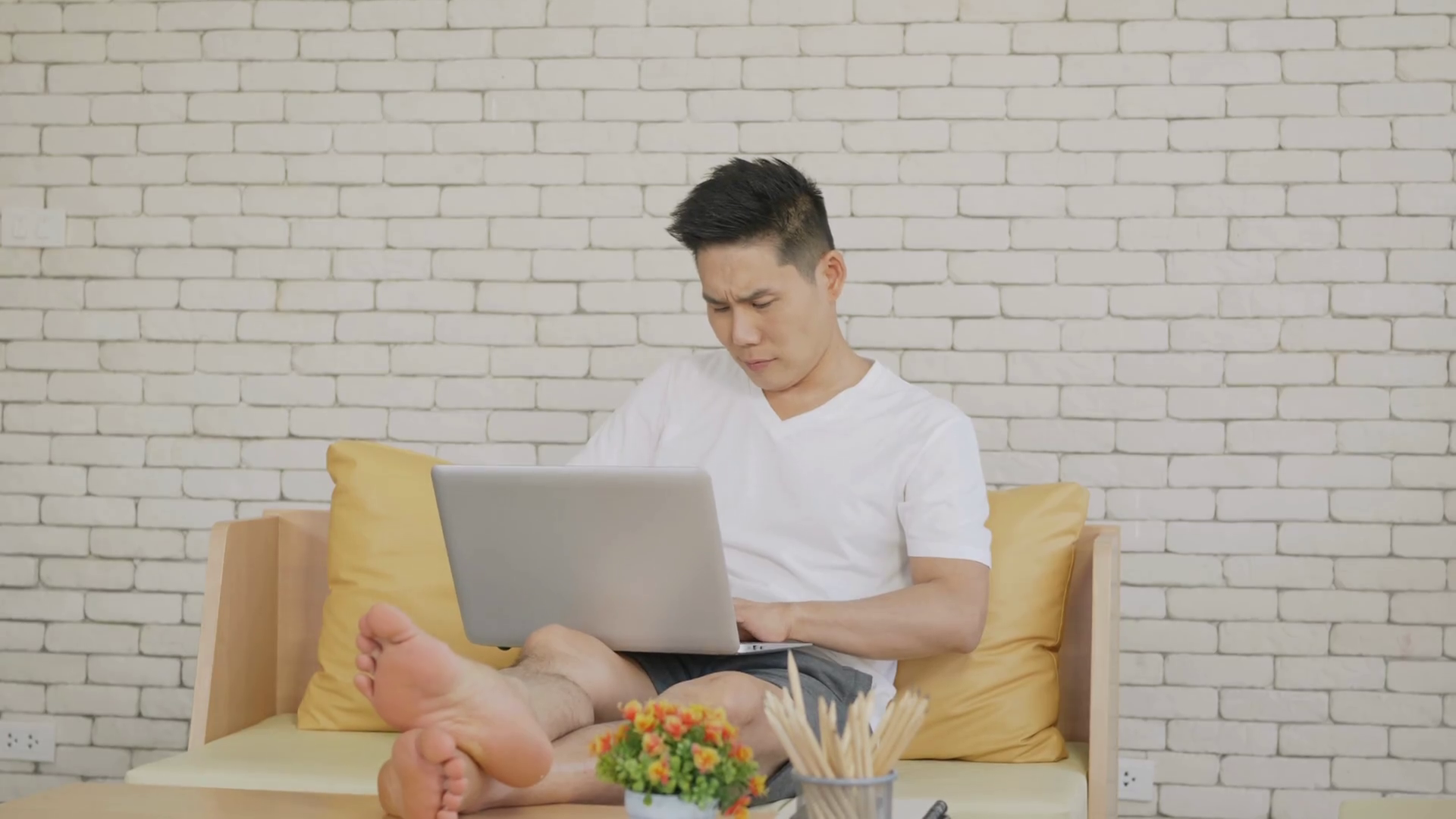 Happy Asian handsome man using and working with a laptop with online ...