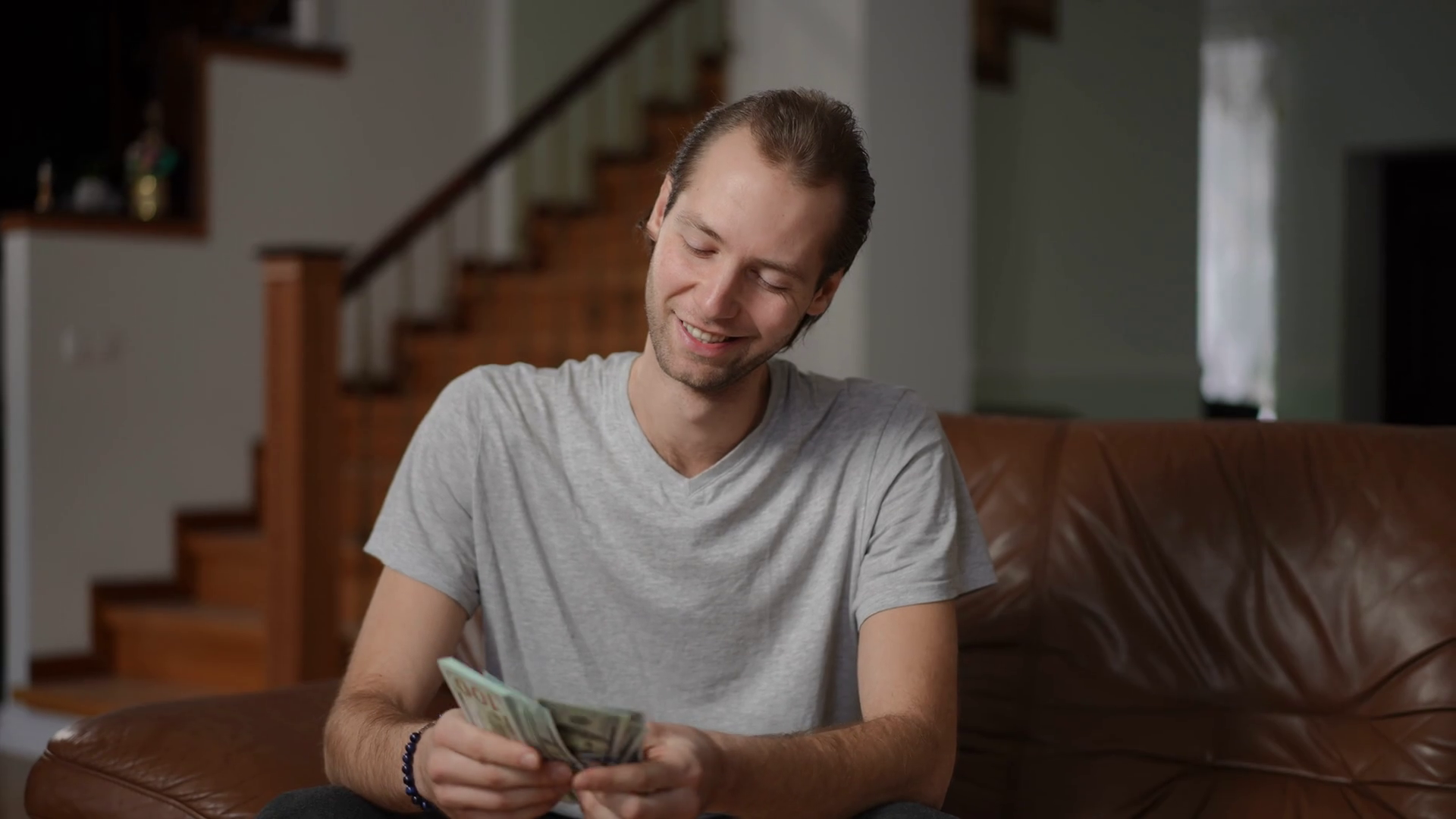 A Young Man Is Happily Counting Cash Sitting Stock Footage SBV ...