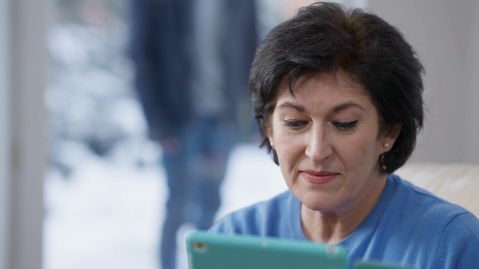 Close-up portrait of Caucasian woman using tablet and noticing masked ...