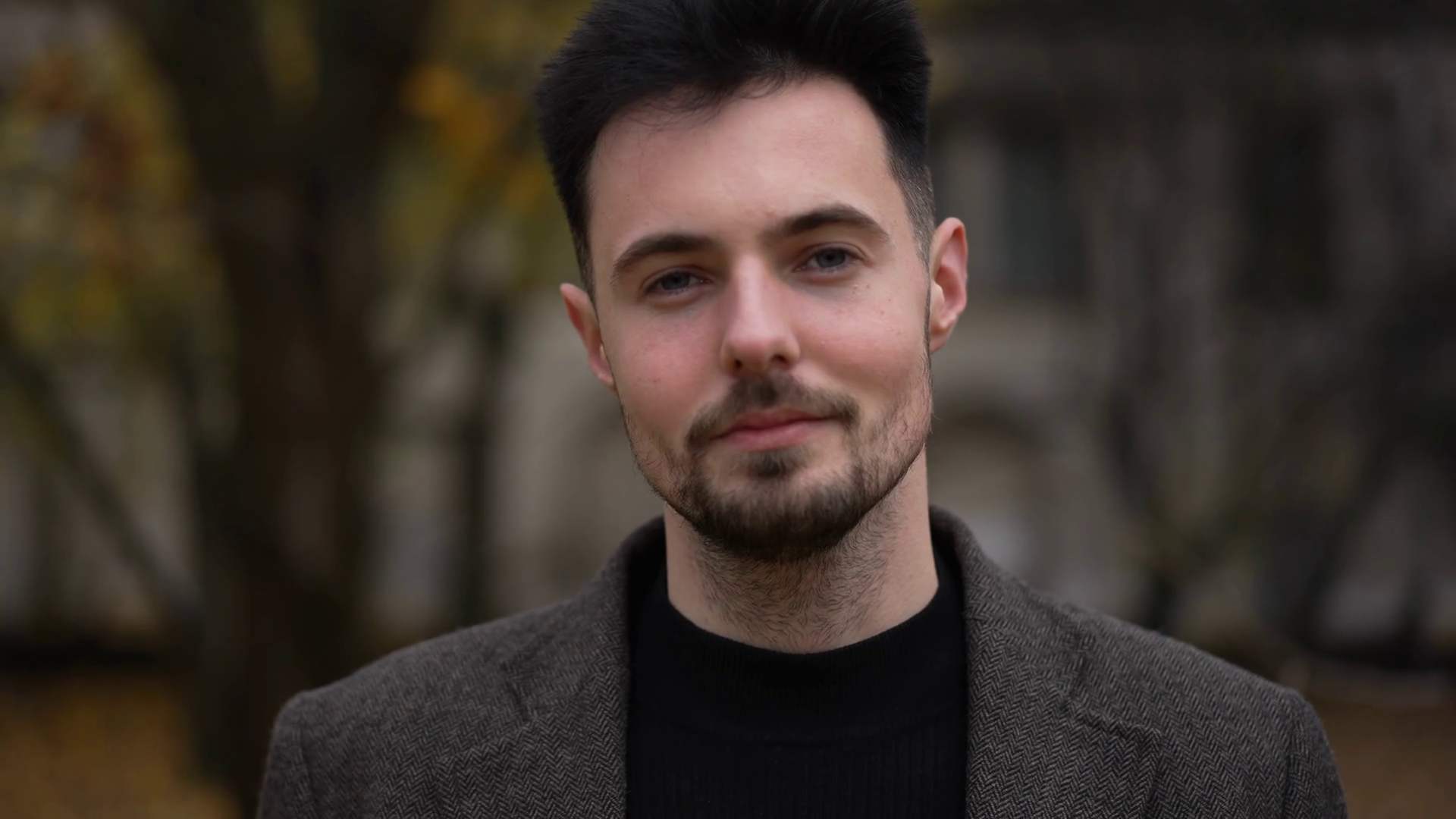 Front view smiling handsome man covering face with yellow fallen tree ...