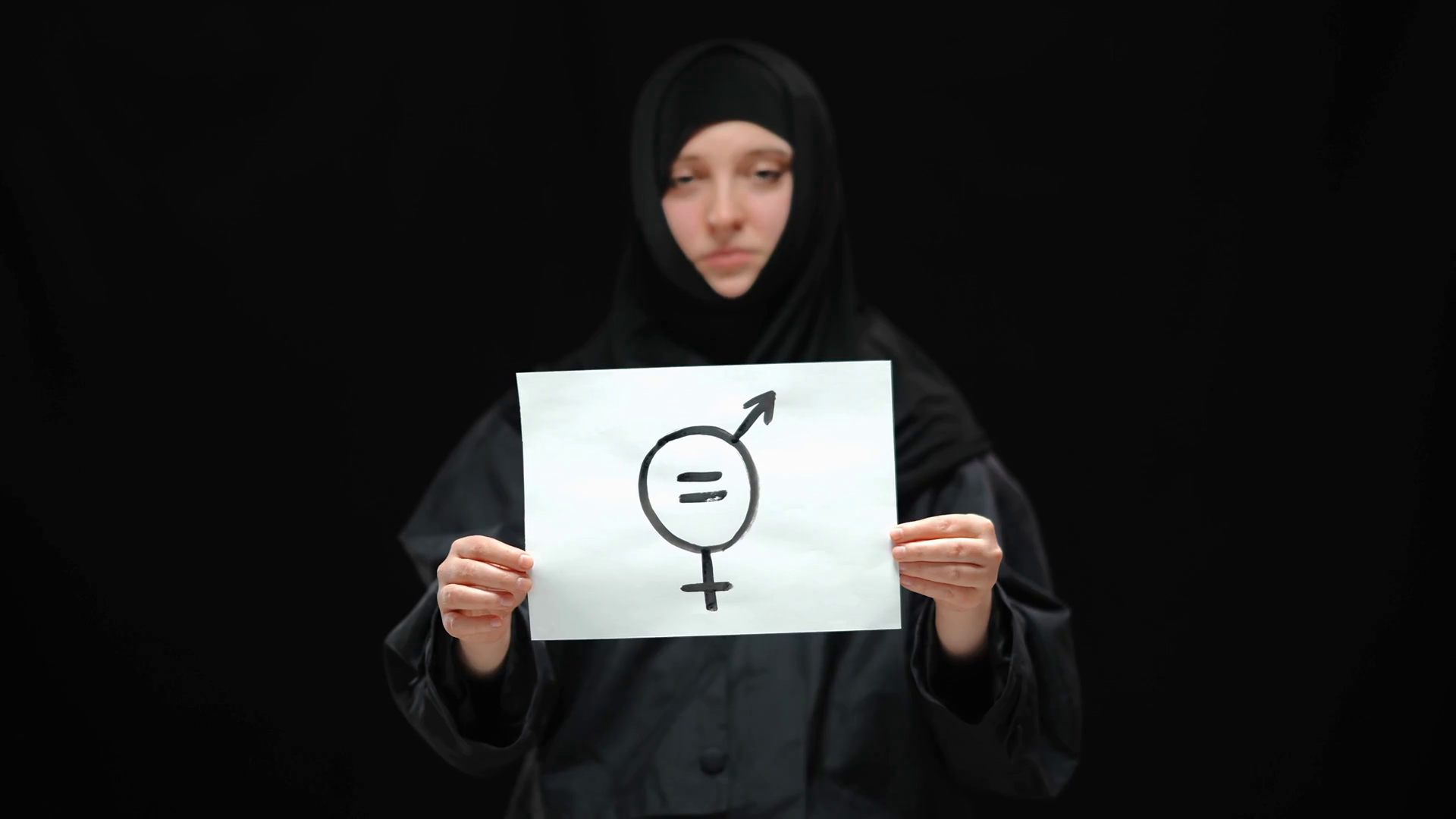 Close-up sign of gender equality with blurred woman in hijab at ...