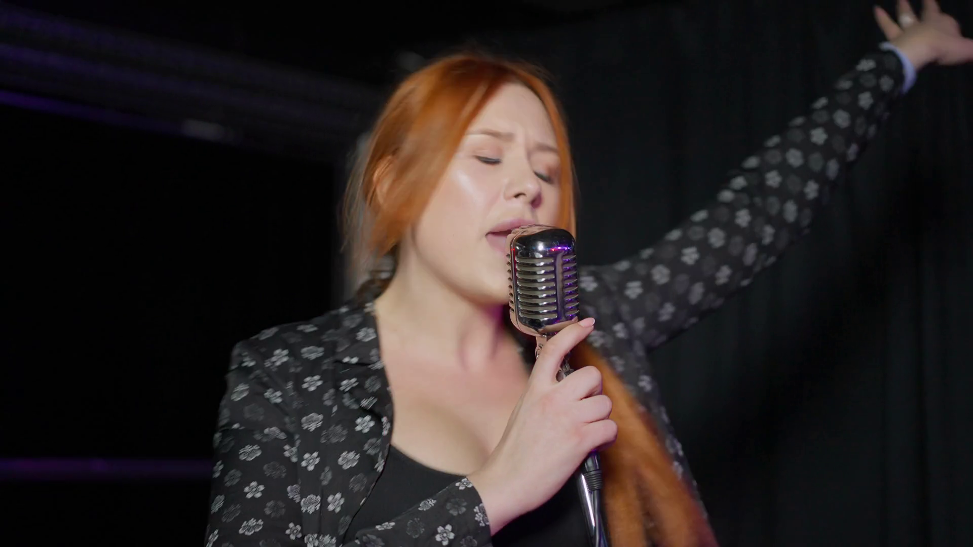 Redhead young Caucasian talented woman singing with microphone ...
