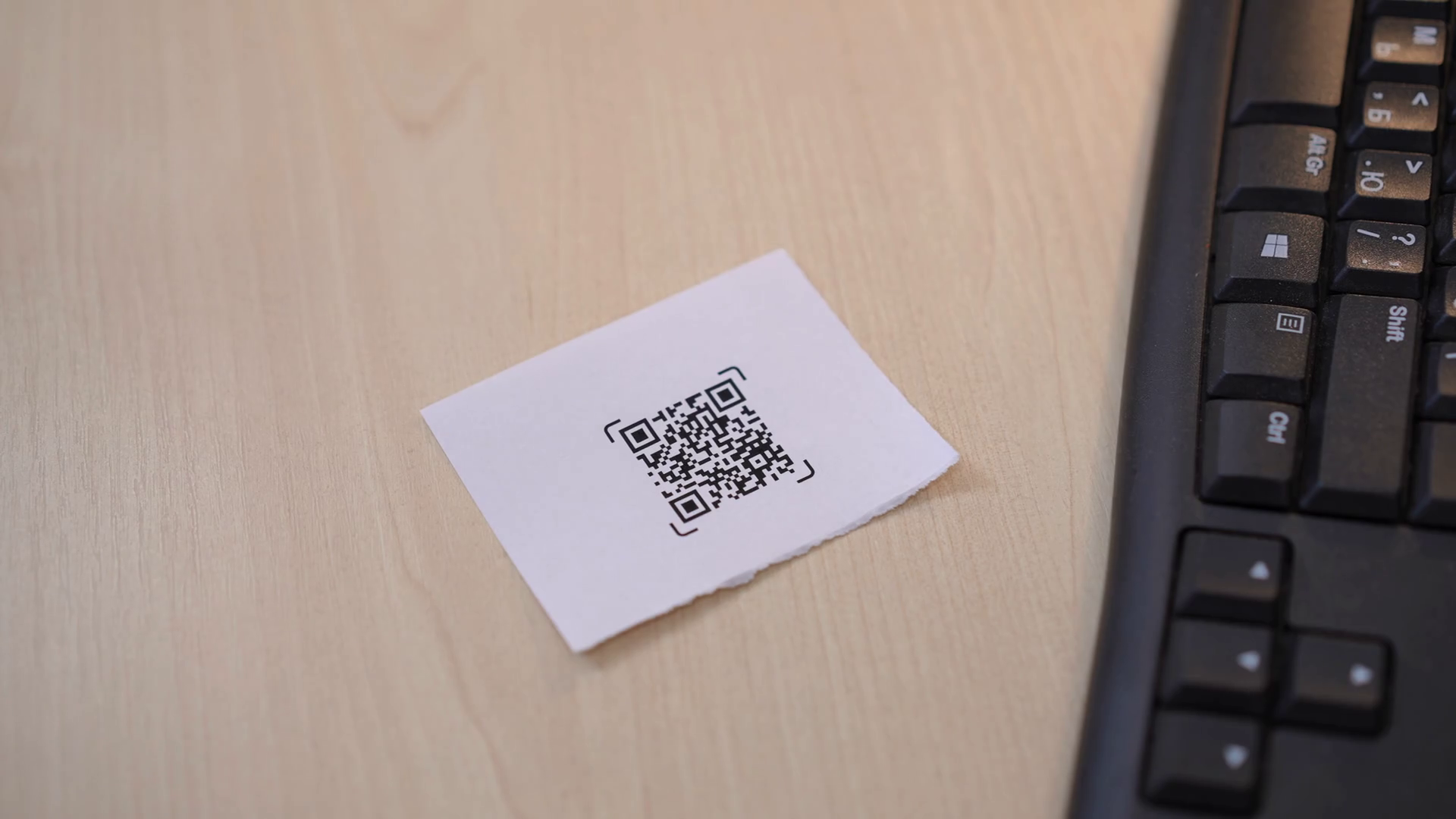 Top view paper with QR code on table with male Caucasian hand using ...