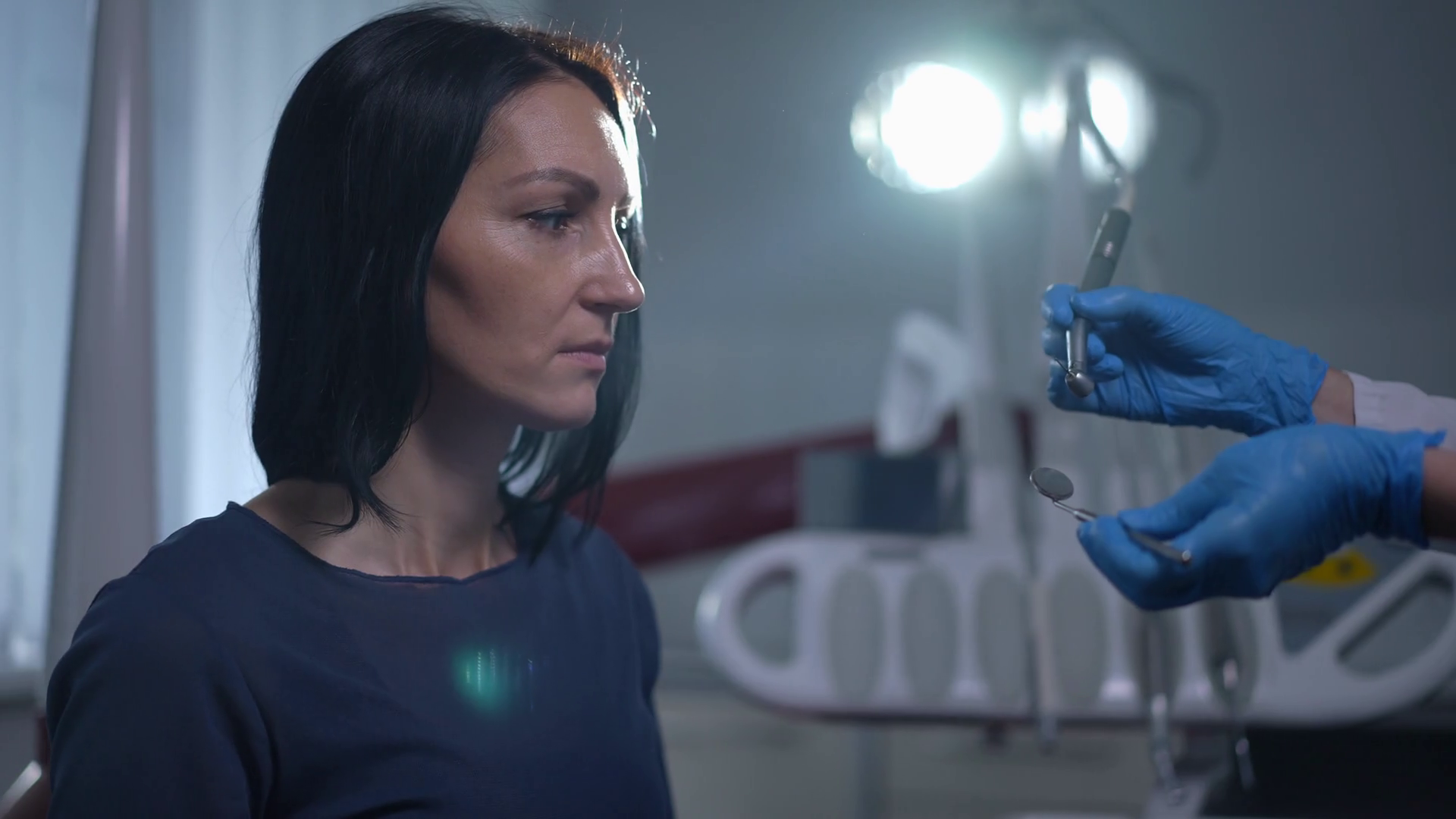 Side view scared stressed woman in darkness in dentist office with ...