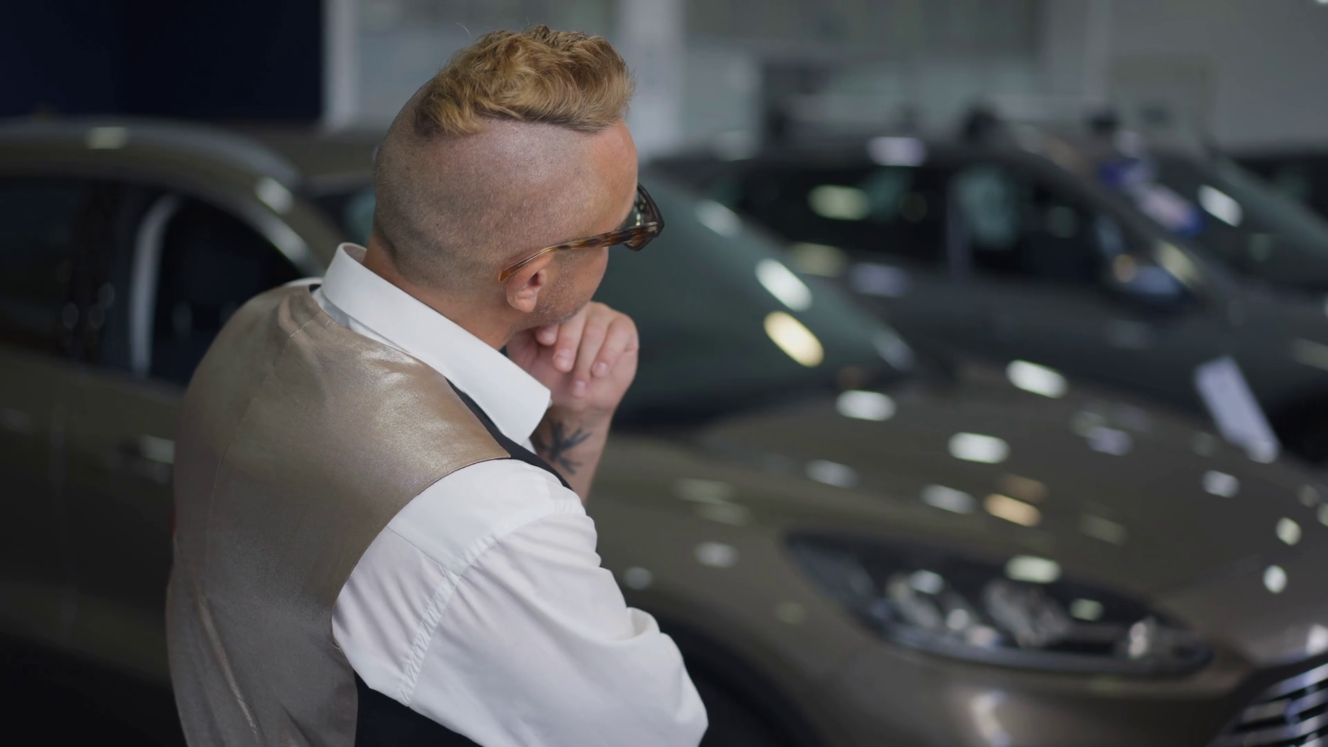 Thoughtful Caucasian rich man admiring row of luxurious cars in ...
