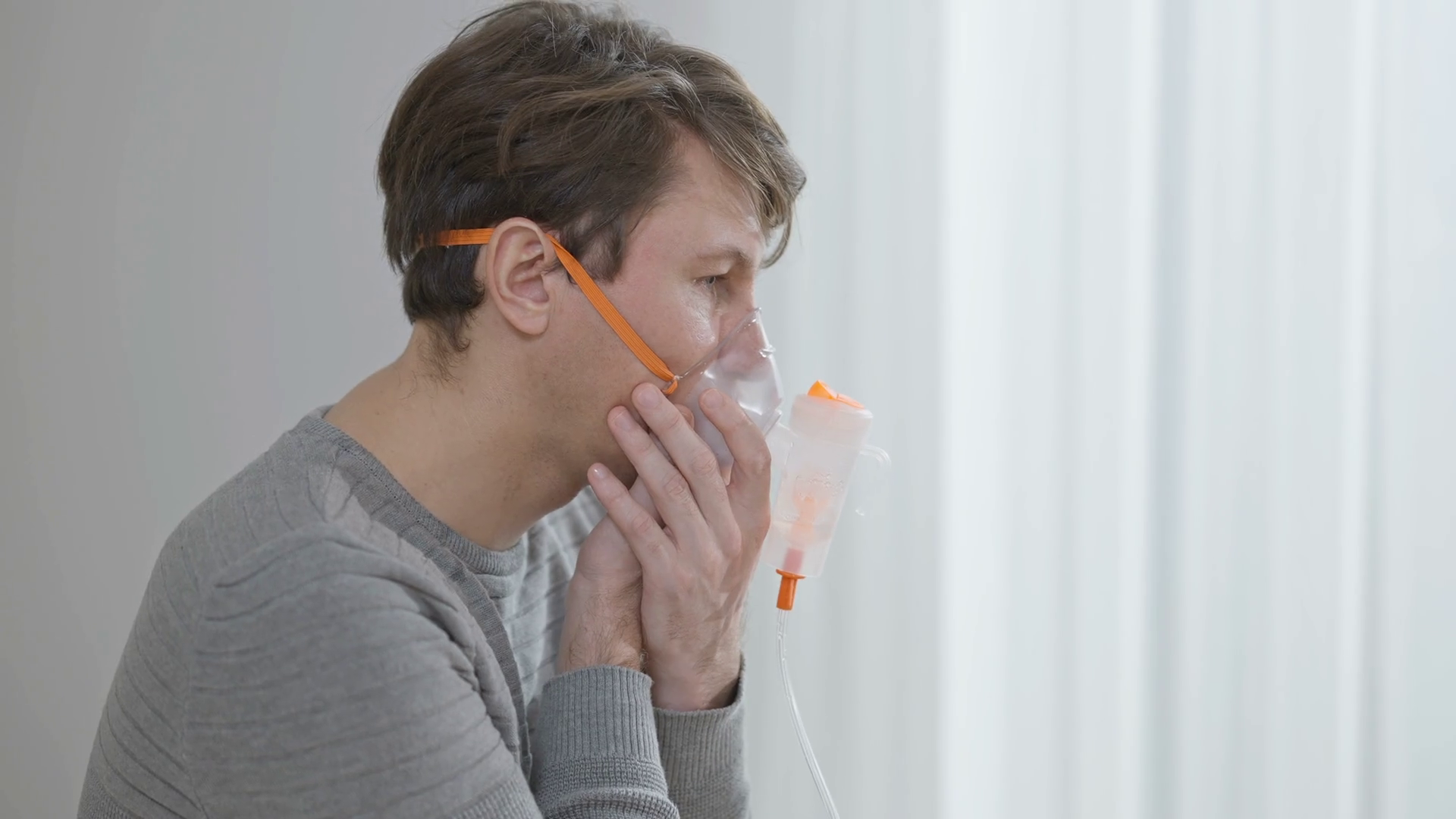 Side view of concentrated brunette Caucasian man inhaling and exhaling ...