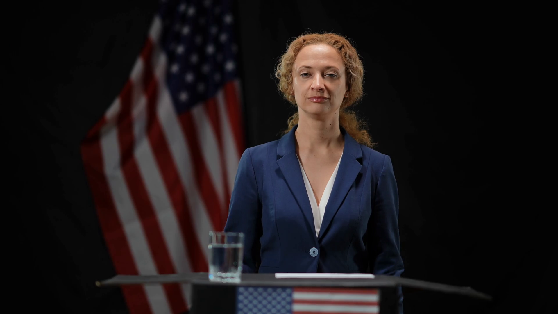 Smiling elegant confident politician woman standing at tribune showing ...