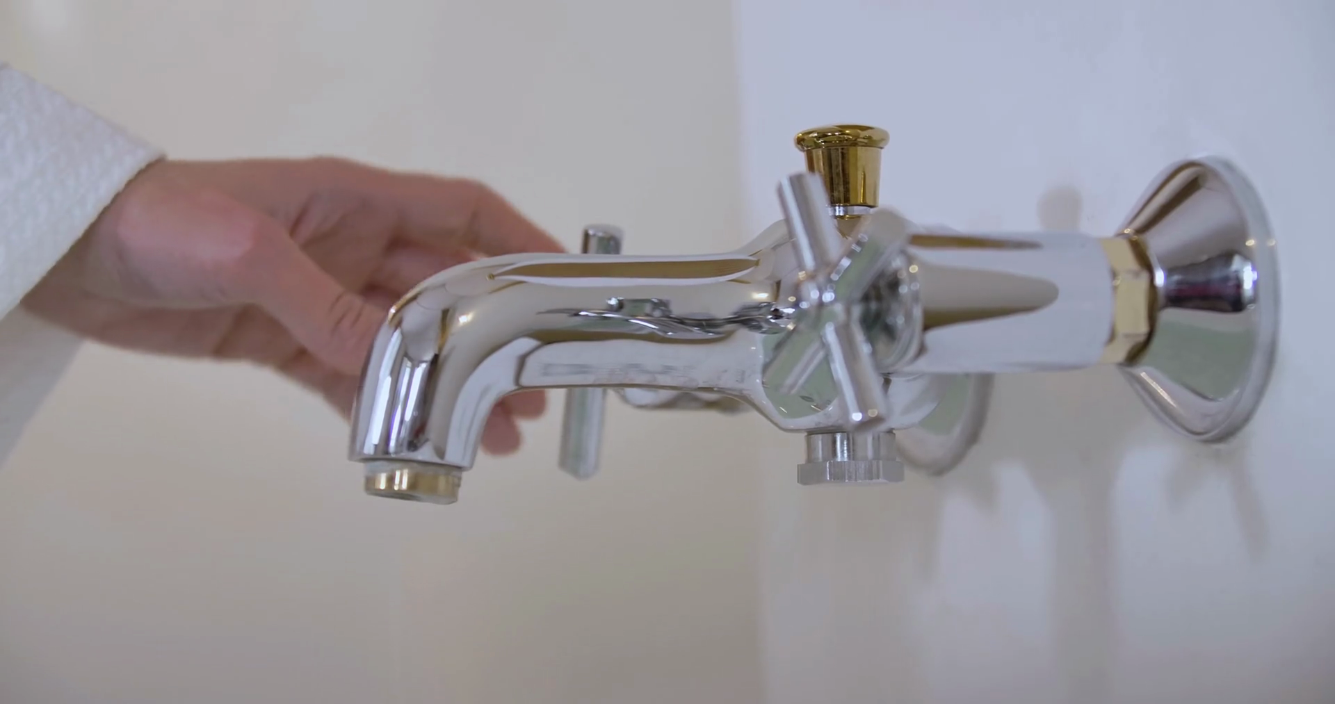 Close-up of female Caucasian hand turning on water and checking ...