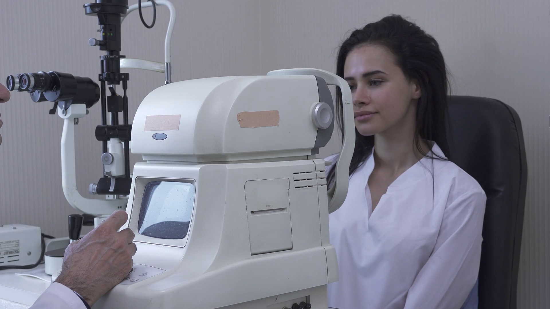 Pretty Young Woman Do Eye Test At Clinic Sitting In Front Of Doctor In Pretty Young Woman Do Eye Test At Clinic Sitting In Front Of Doctor In