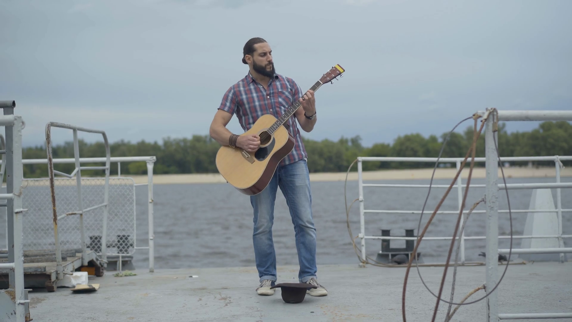 Wide shot of angry musician stop playing guitar and hitting hat with ...
