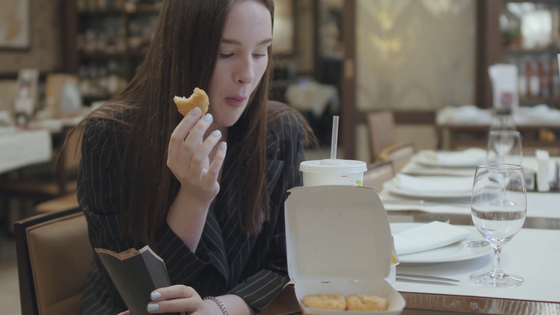 Young beautiful woman sitting at the expensive restaurant and eating ...