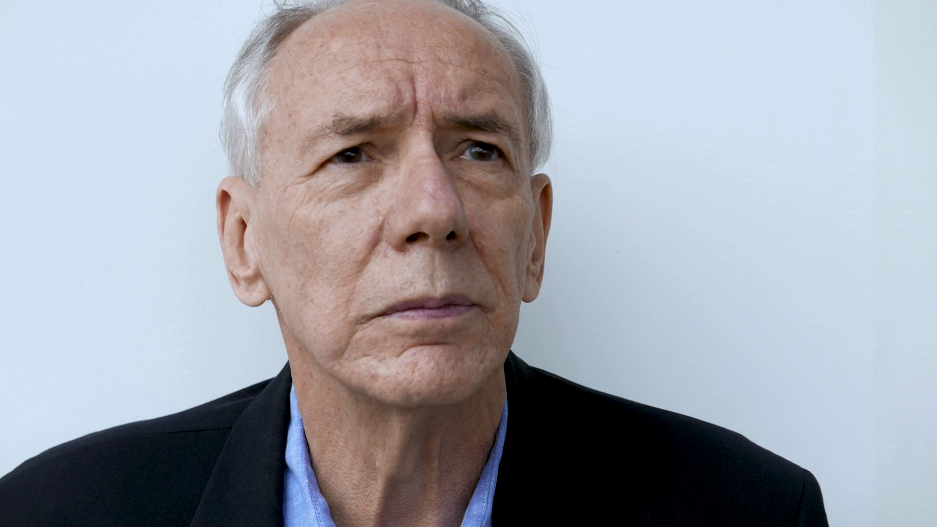 Old Man Looks Into Camera In Front Of White Stock Footage SBV-333797323 ...